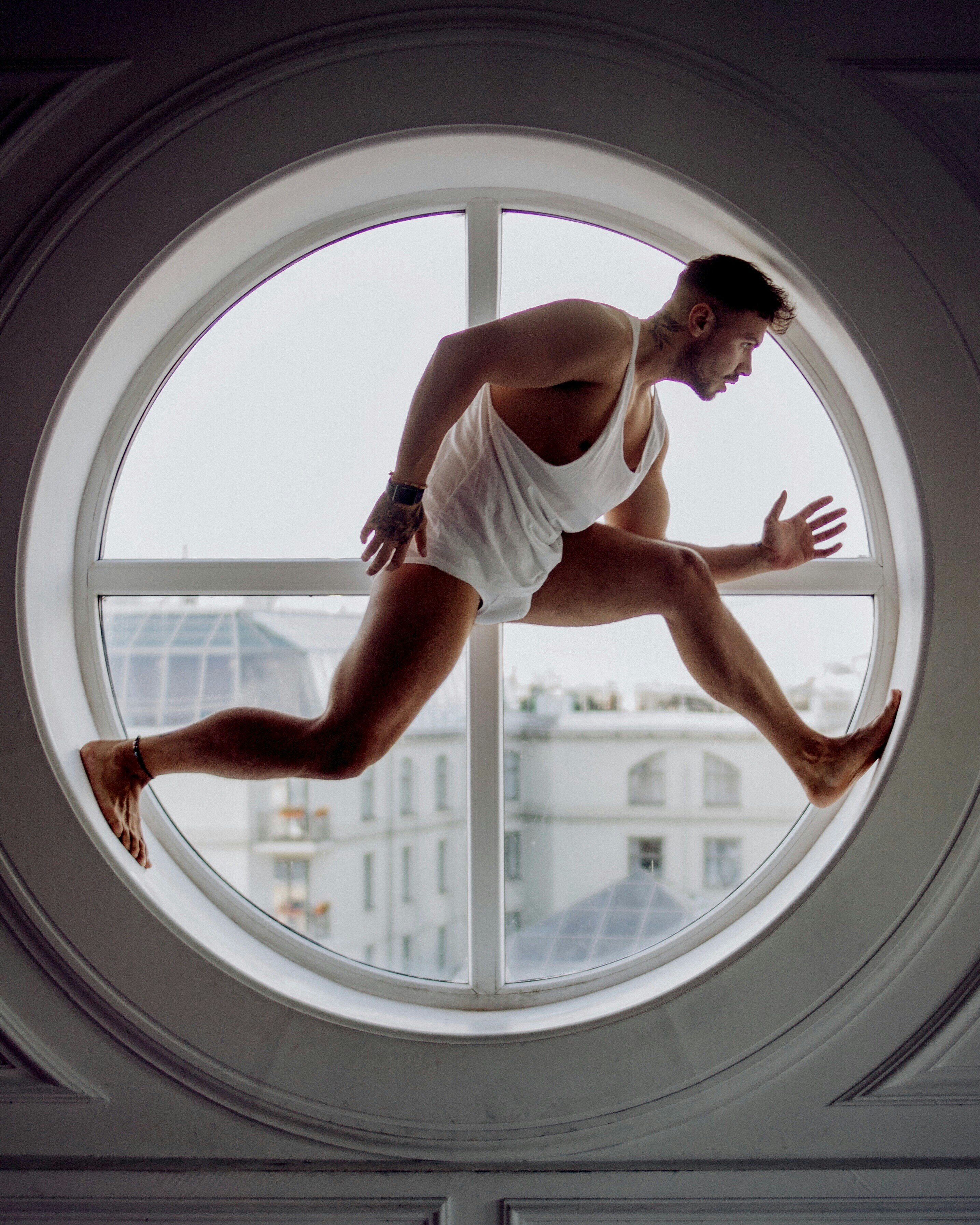 Circle of Motion: A Runner Leaps Across a Circular Window