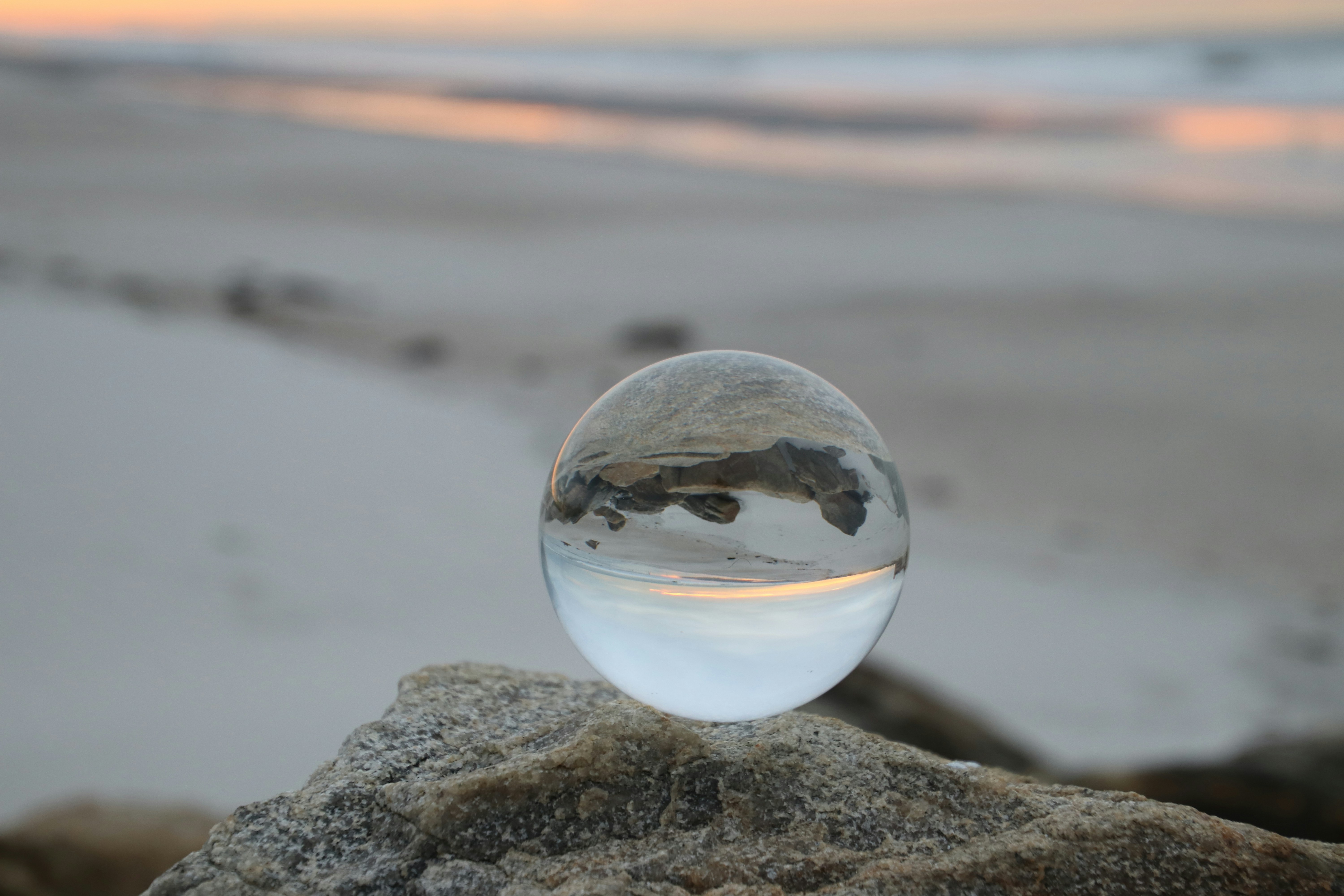 Reflection on a Glass Globe: A Quiet Beach Moment