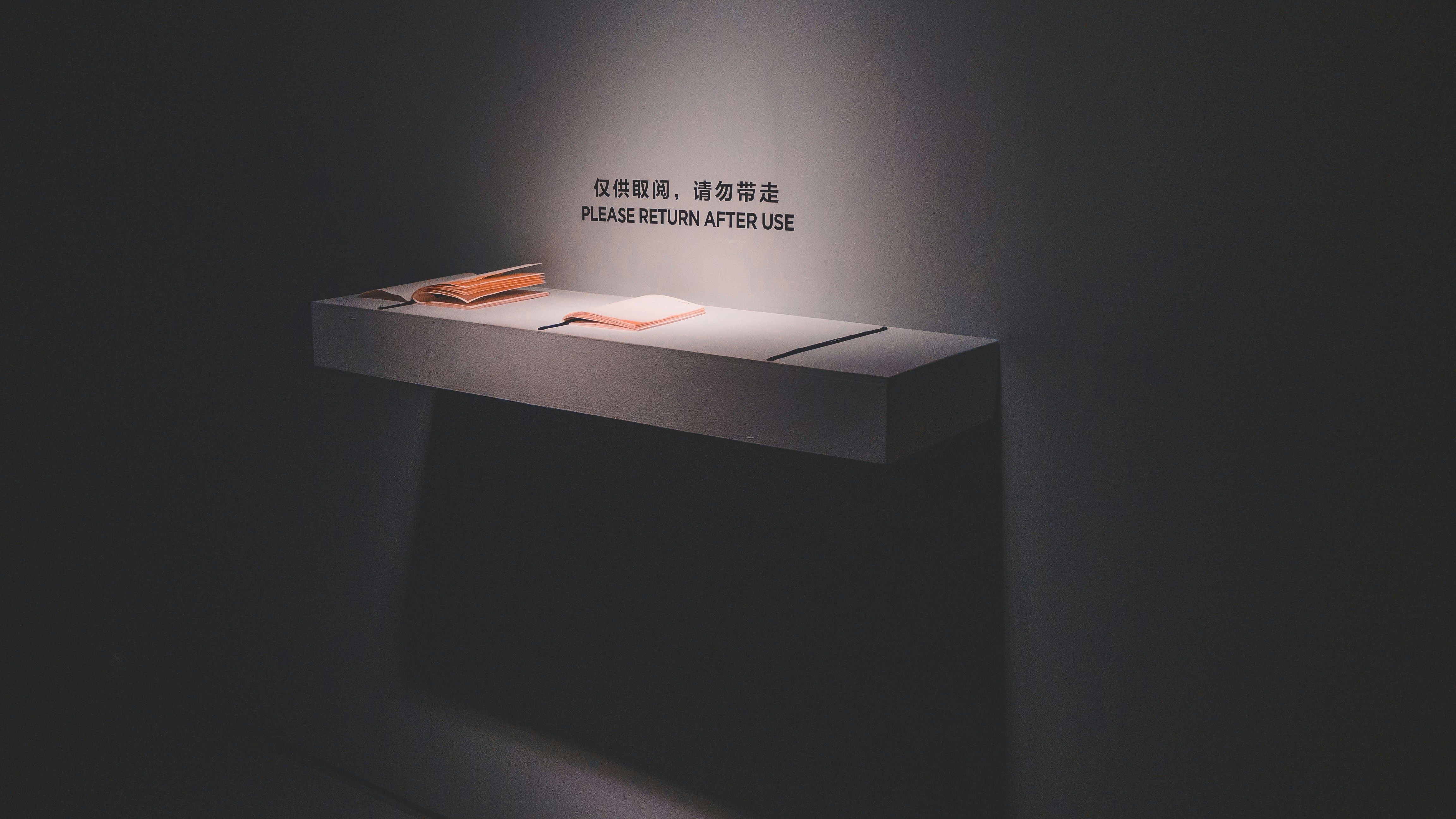 Please Return After Use: A Spotlighted Floating Shelf in a Dark Room