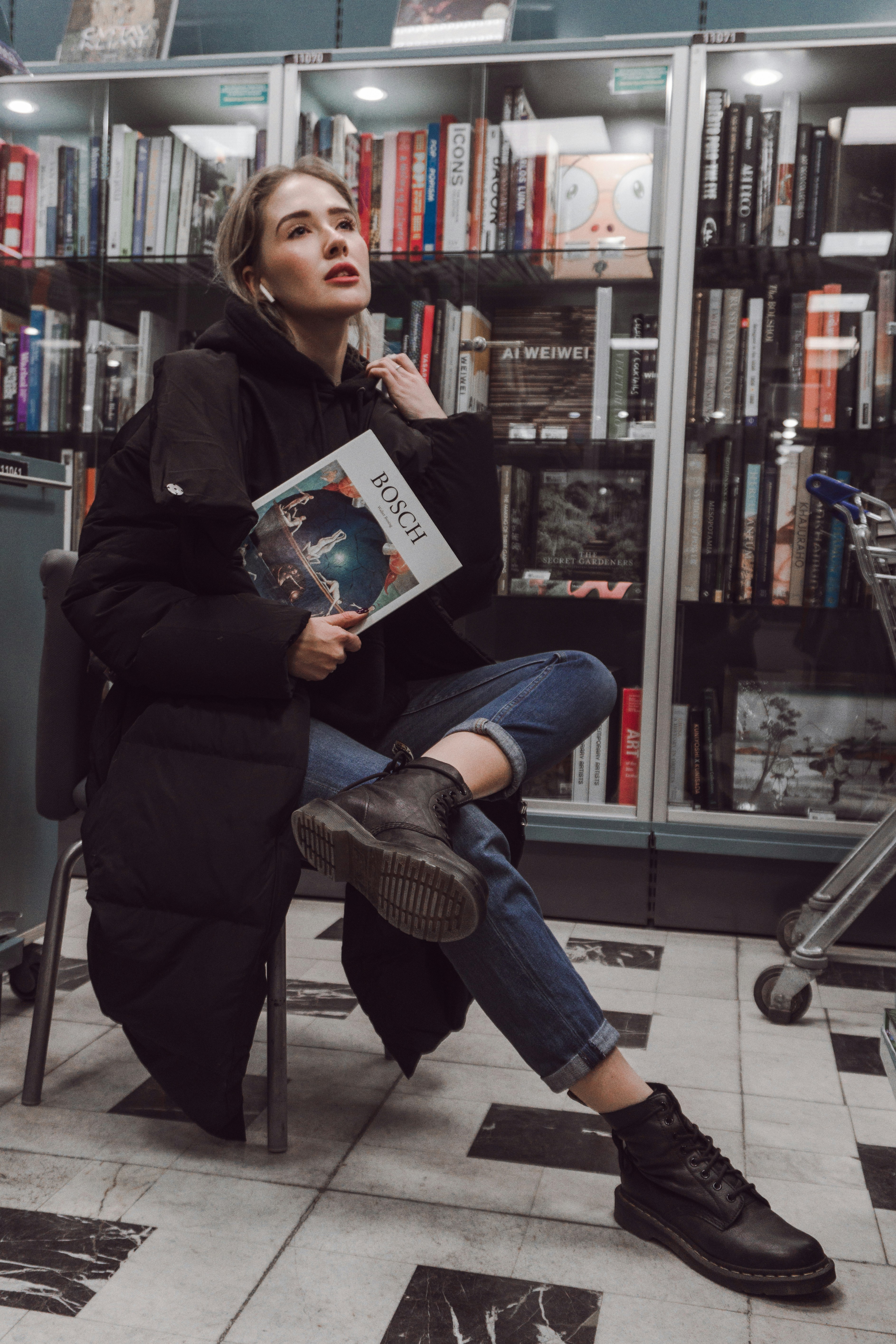 Contemplation Between Aisles: Portrait in a Glass-Walled Bookstore
