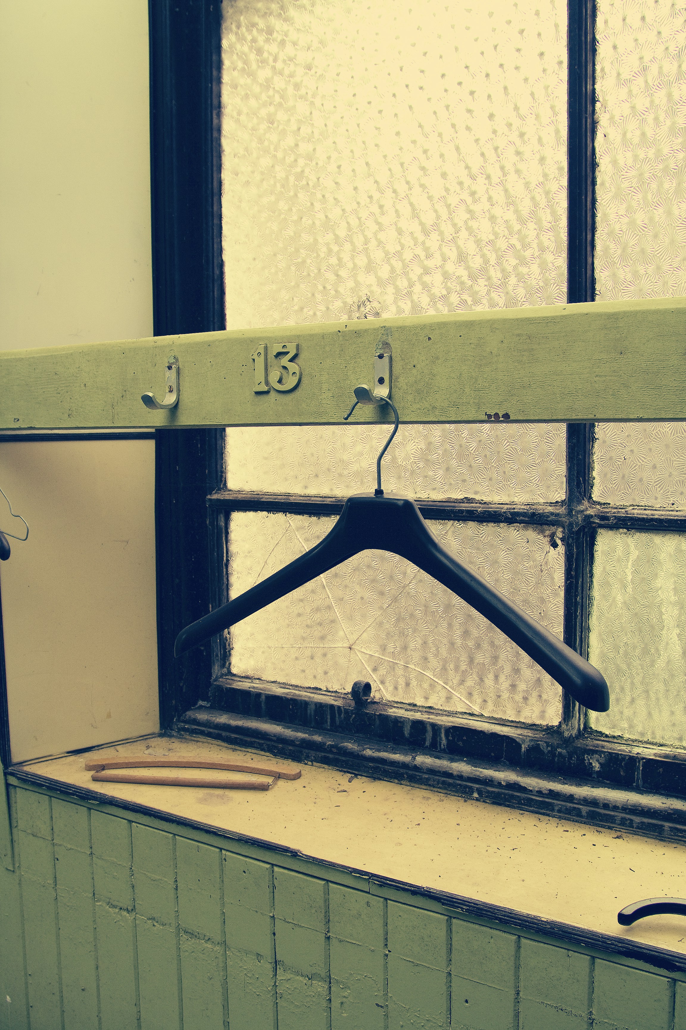 Hanging in Silence: A Dormant Wardrobe by the Fogged Window