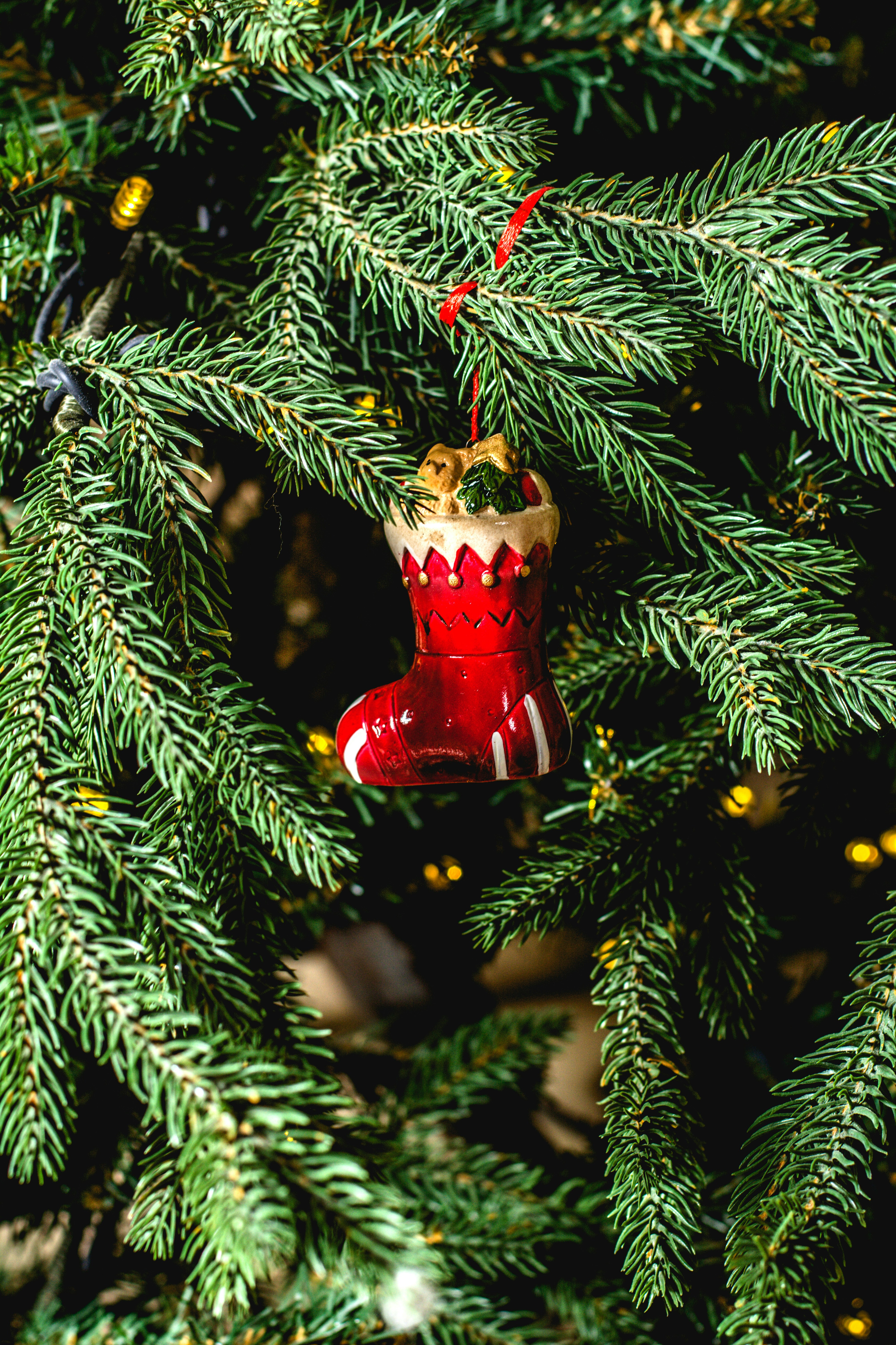 Tiny Christmas Boot Ornament Nestled in Evergreen Fronds
