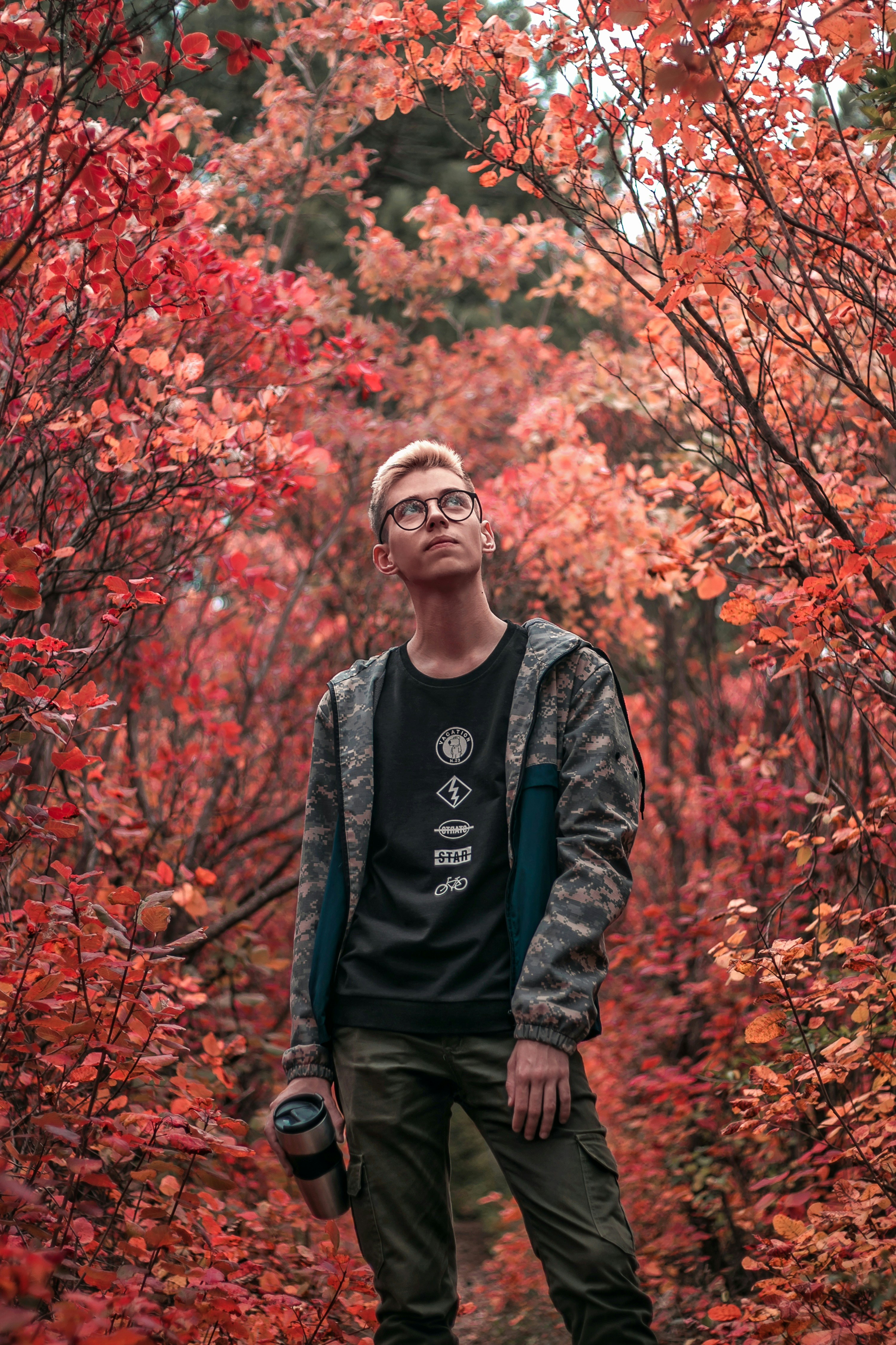 Portrait in Scarlet: A youth amid autumnal brushwork