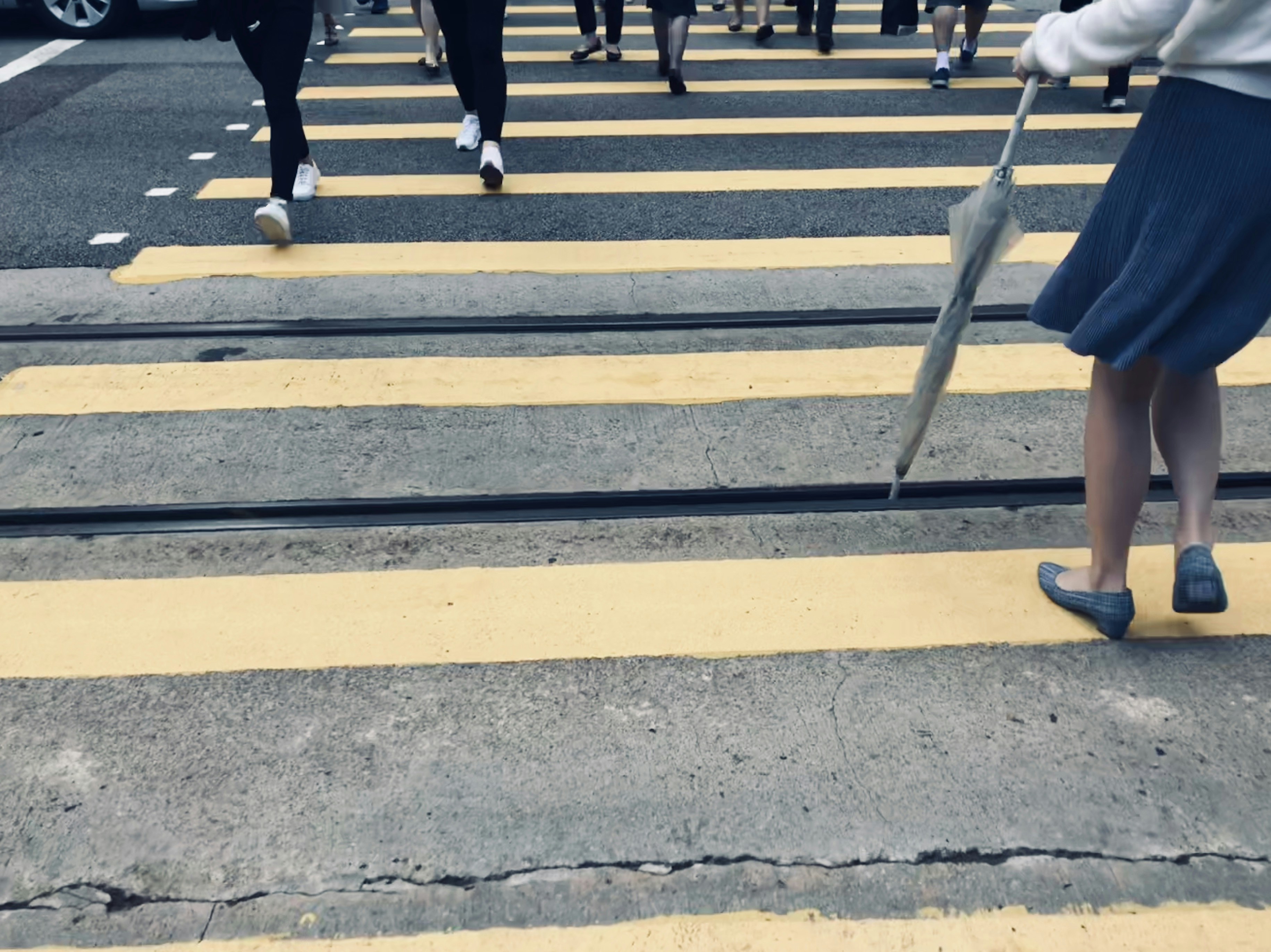 Crosswalk Rhythm: A Quiet Pause Among Yellow Stripes and Moving Feet