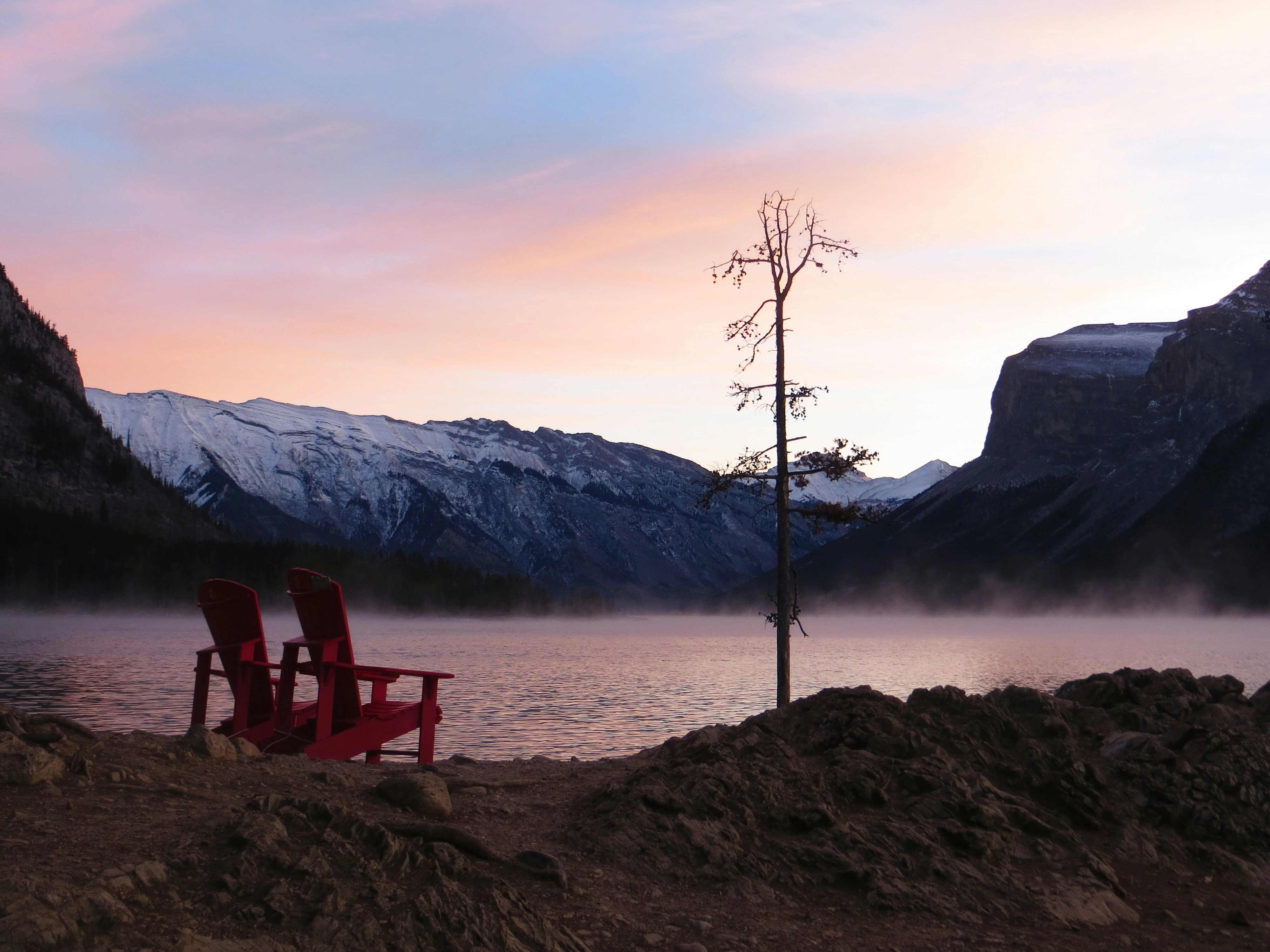 Dawn on a Misty Lake: Red Chairs on the Shore