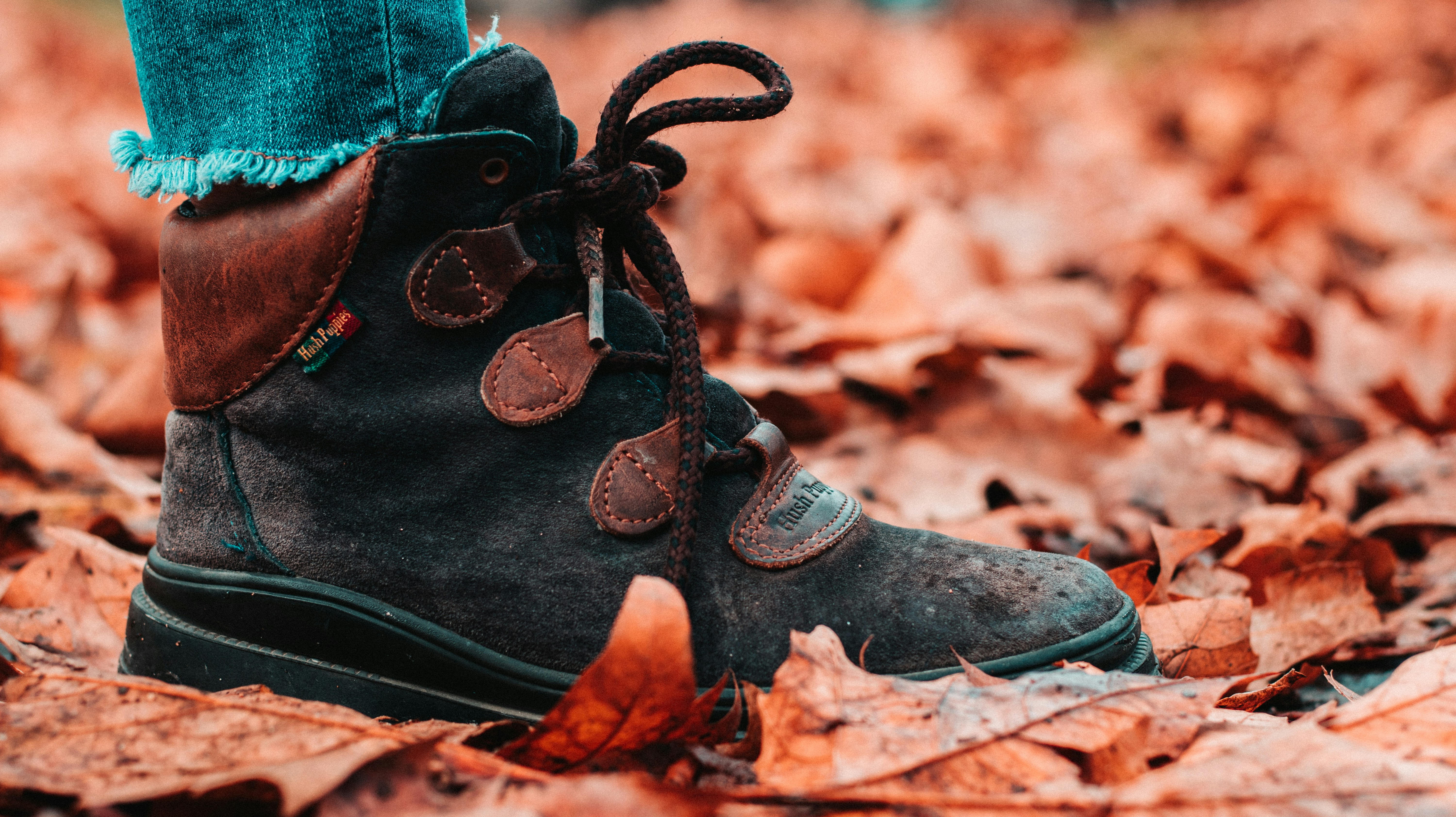 Rugged Boot on a Mosaic of Autumn Leaves
