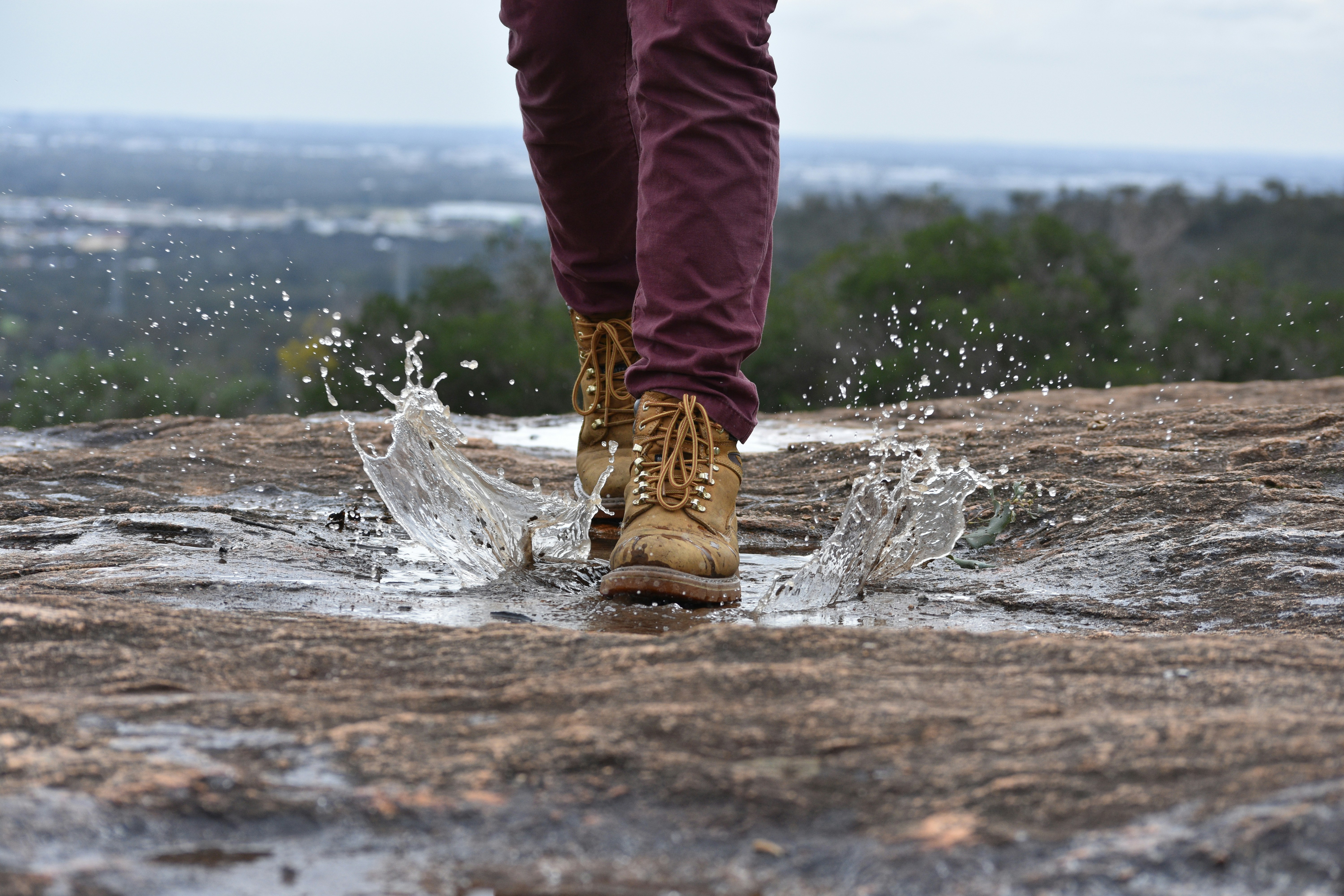 Boots on Wet Granite: a Splash-Paced Moment at the Trail's Edge