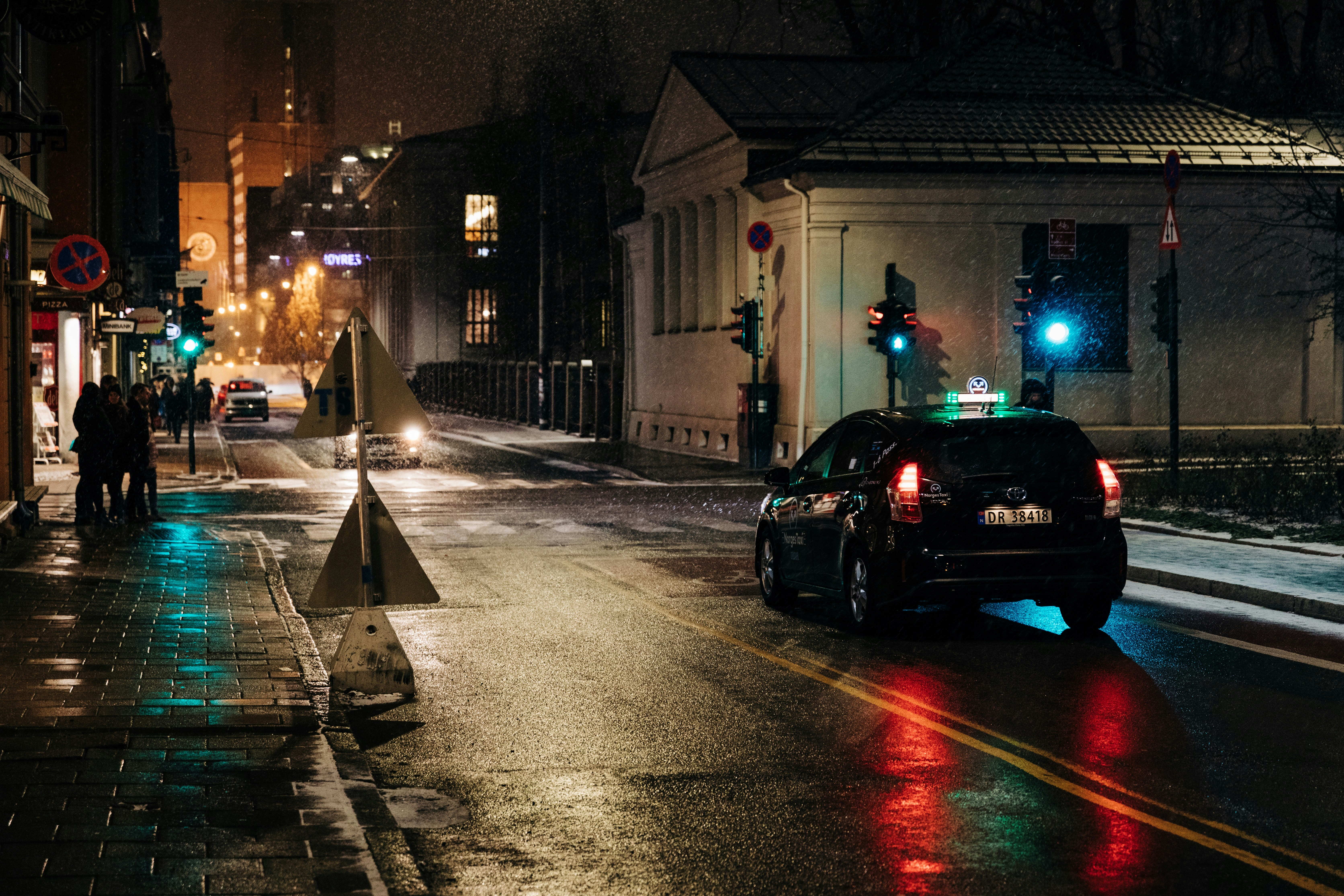 Vehicle passing on road near buildings photo – Free Tarmac Image on ...