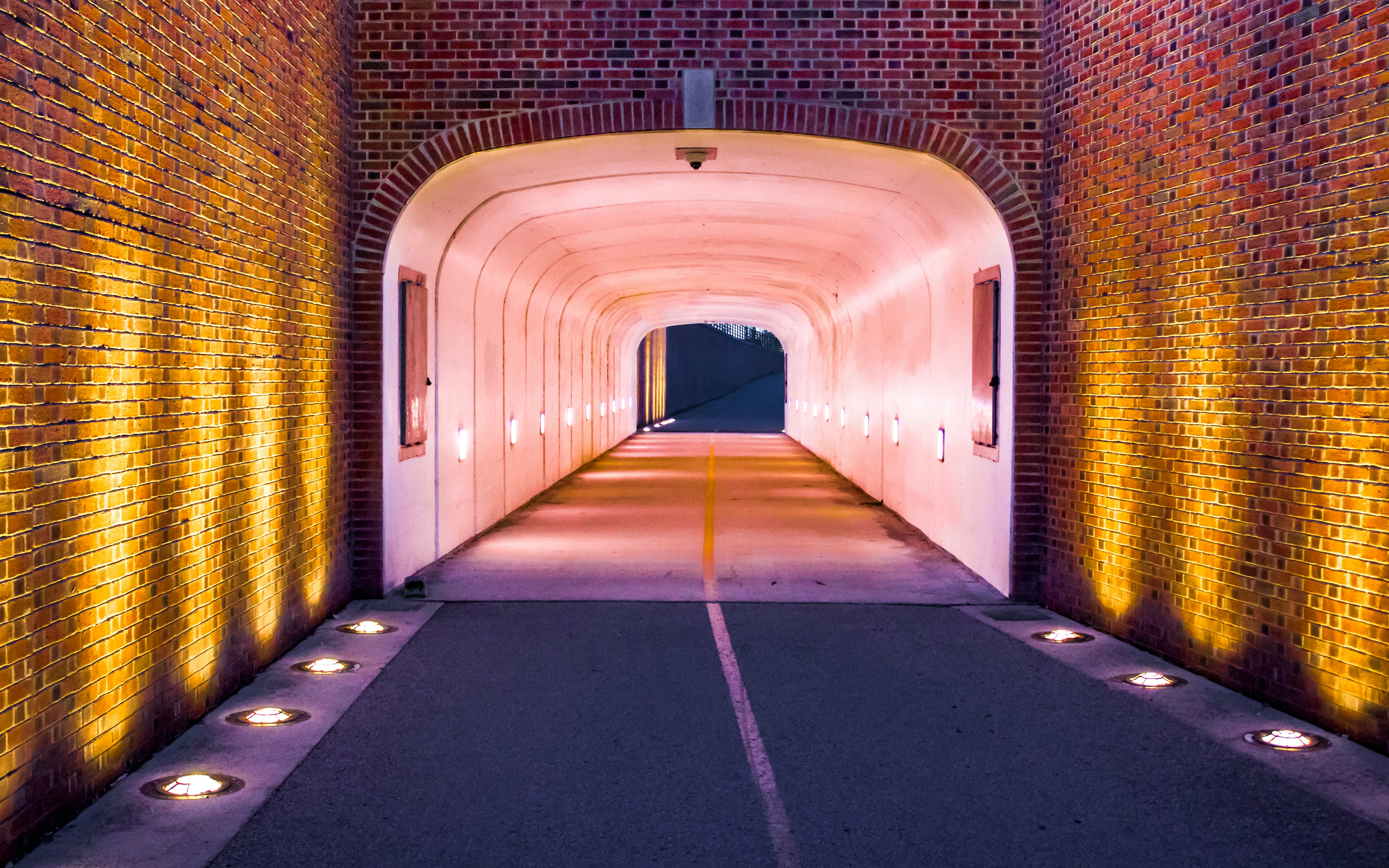 Illuminated Archway: A Tunnel Toward the Quiet Exit