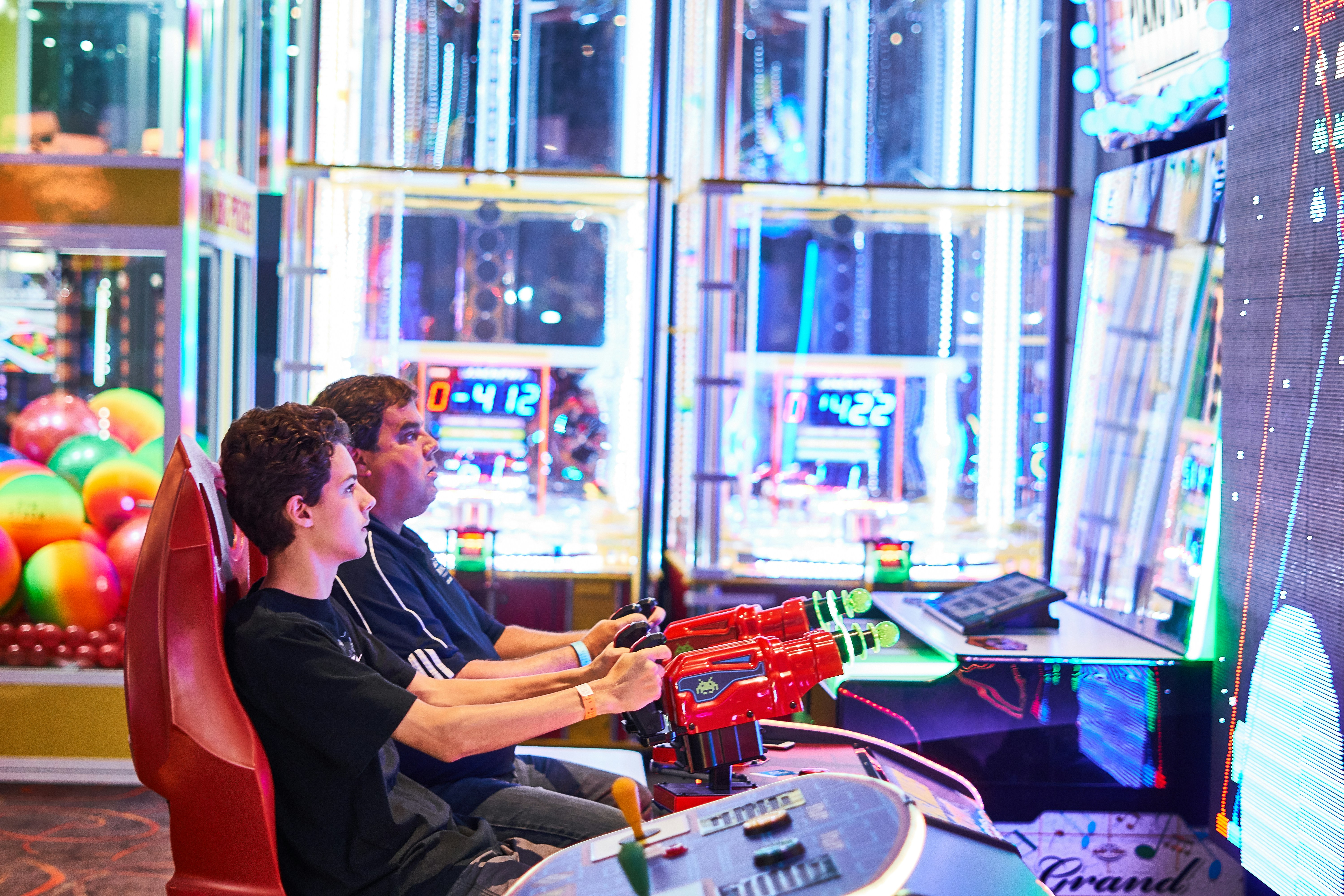 Two men playing arcade game photo – Free Human Image on Unsplash