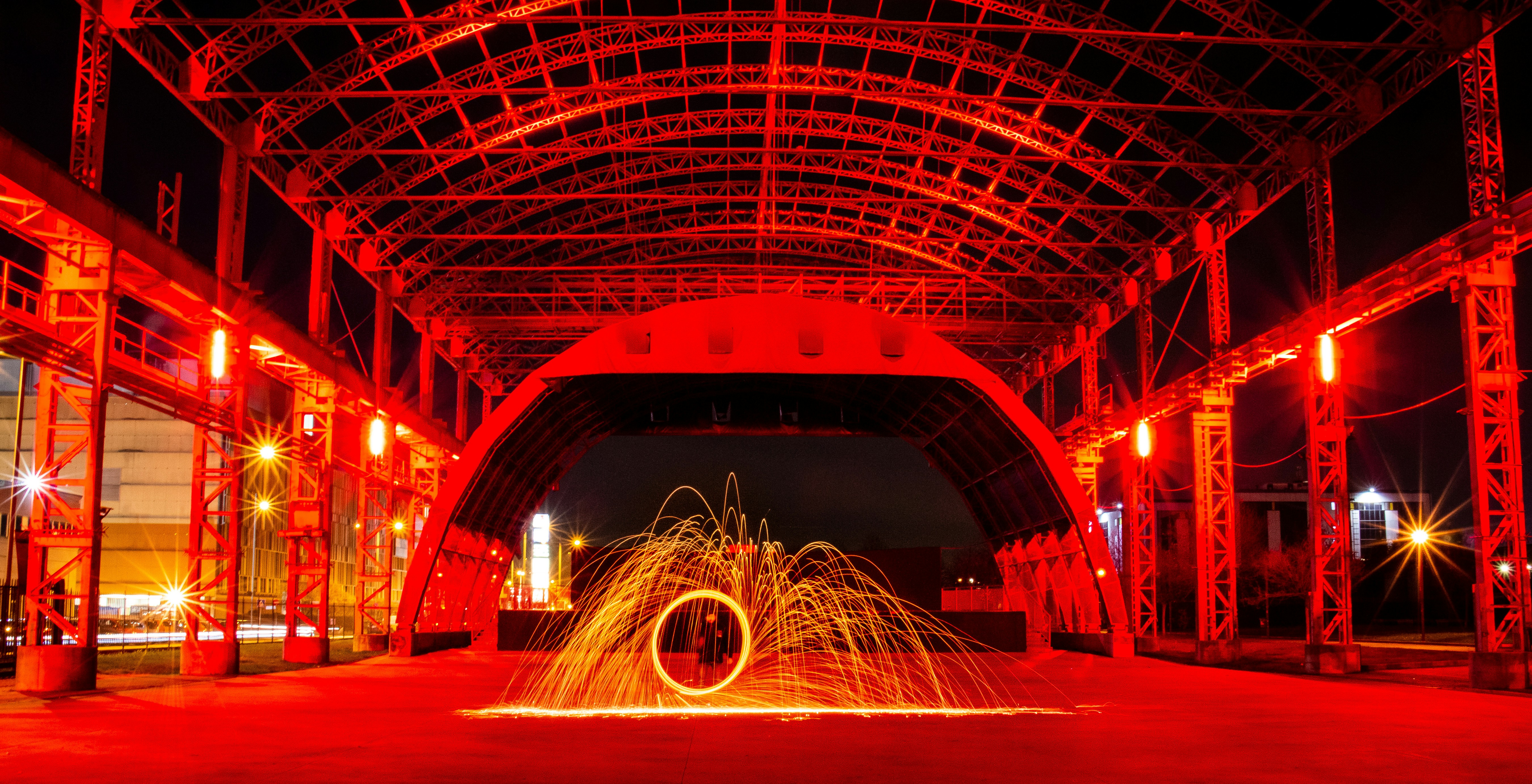 Under the Red Steel: Sparks of Light in an Empty Pavilion