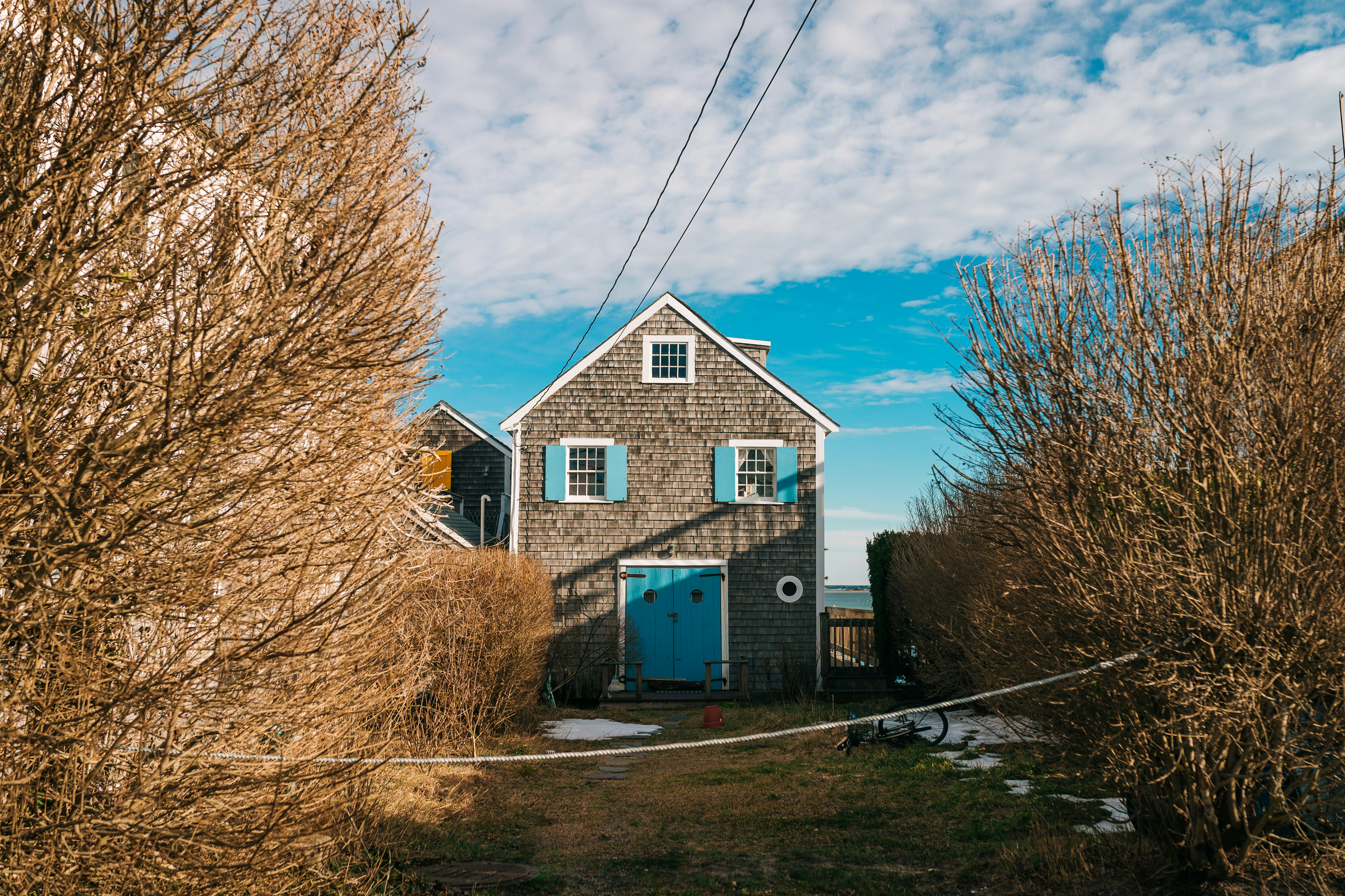 grey brick house near trees during daytime