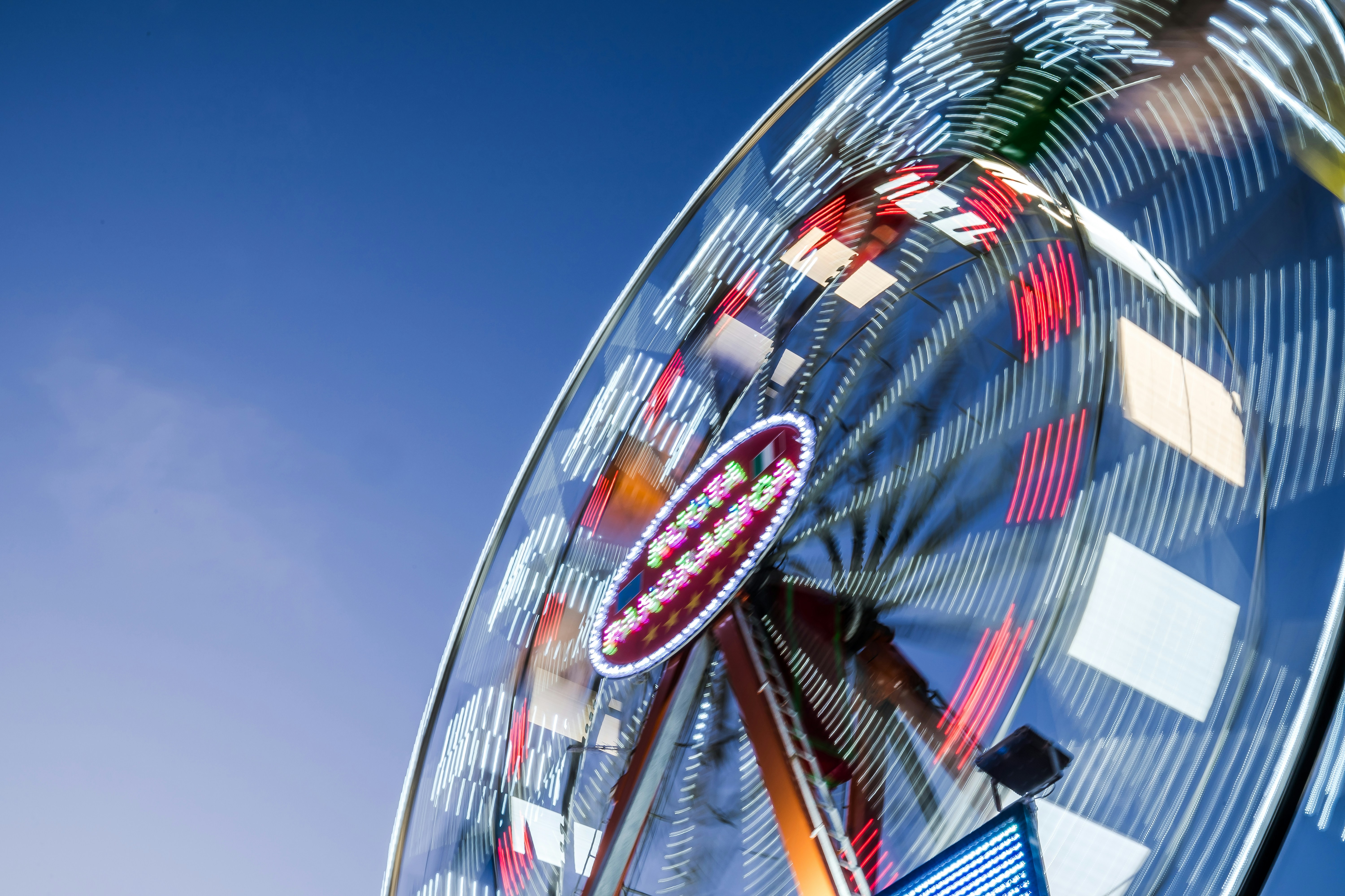 Ferries Wheel lights at sunset by the Garda Lake