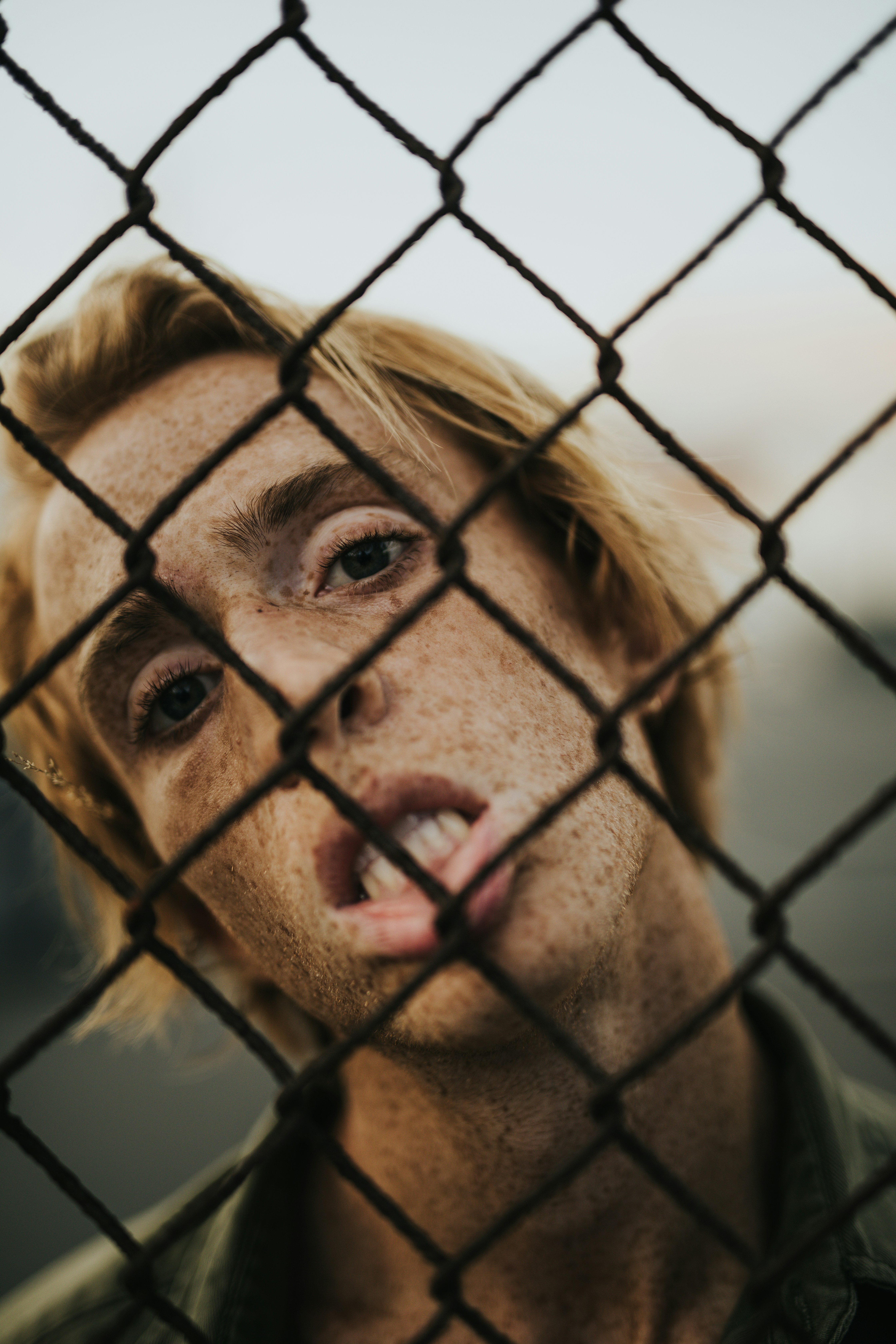 Man behind chain link fence photo – Free Brown Image on Unsplash