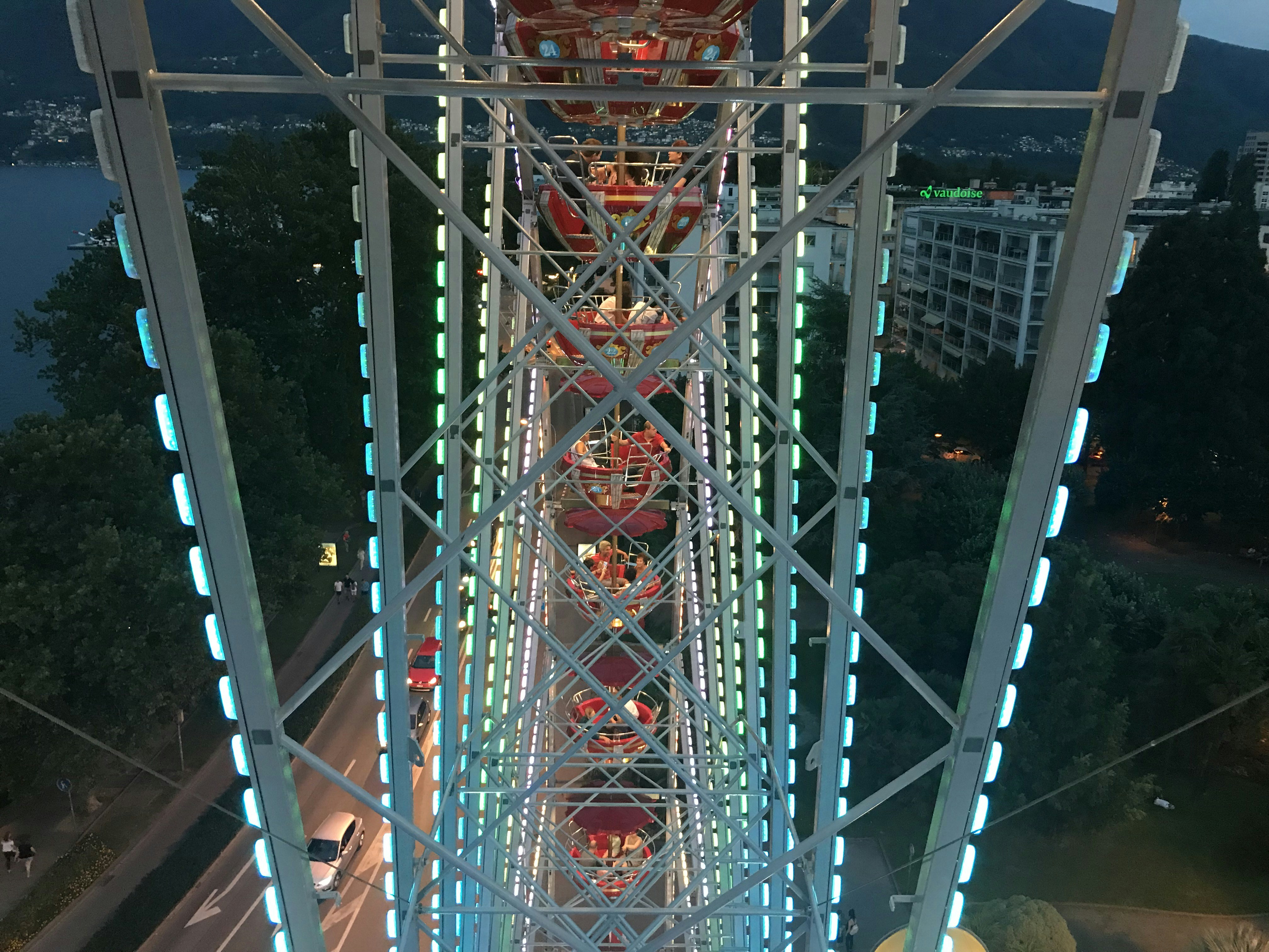 This photo was taken in the nice city of Locarno, they rarely have a ferris wheel. 
When I first have seen it, I was amazed. These colourful lights and the stunning view… 
We had to go on top of it!