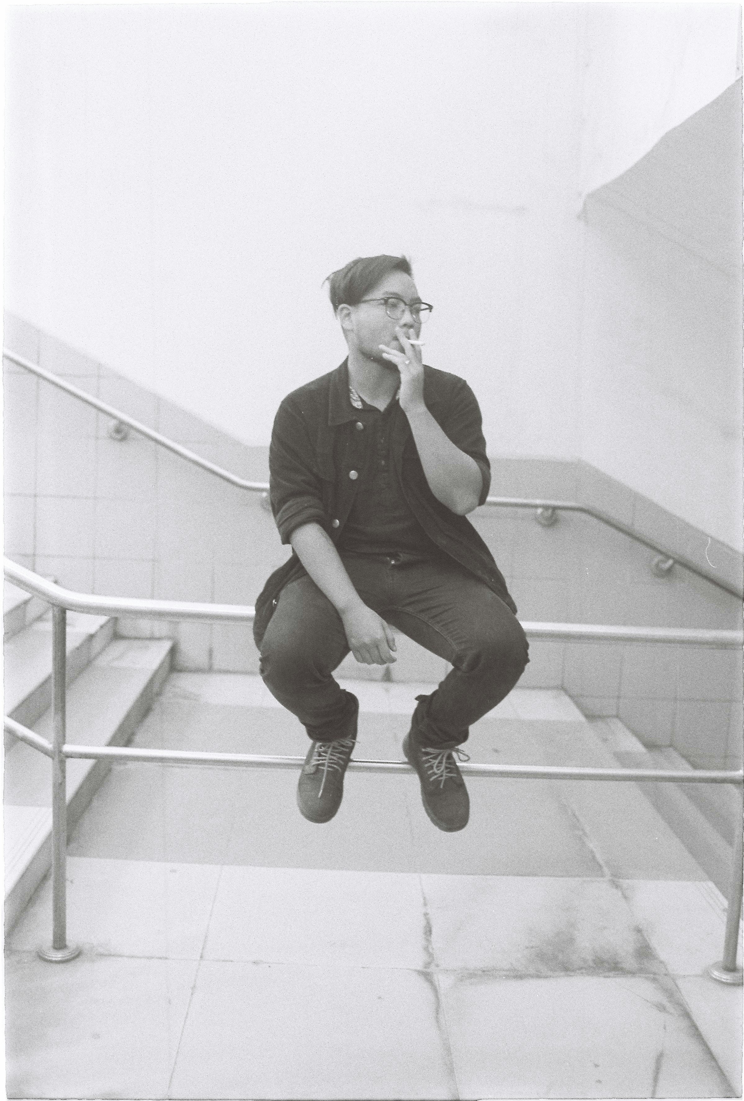 Man smoking cigarette while sitting on railings photo – Free Hà nội ...