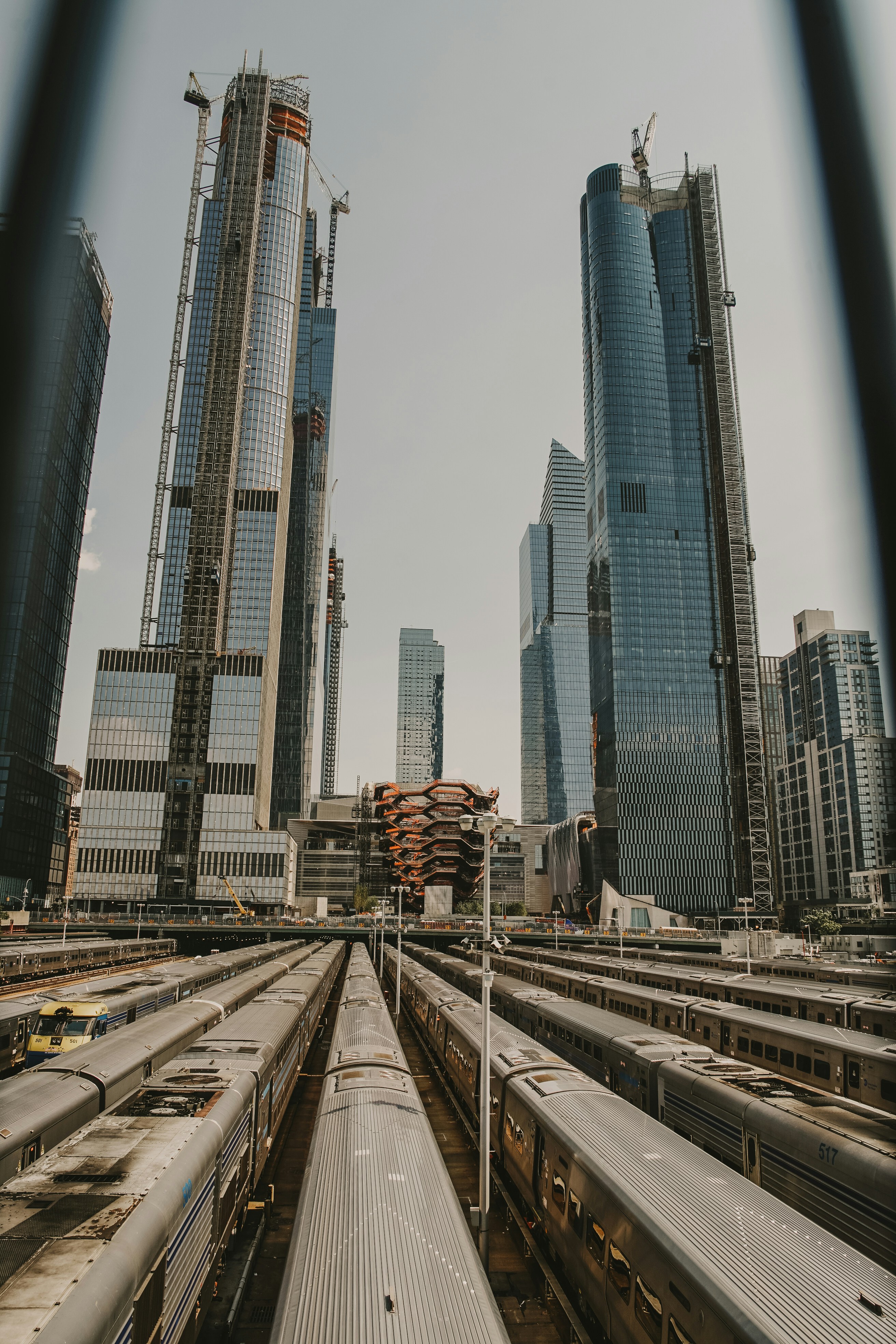 Low-angle photography of trains near building during daytime photo ...