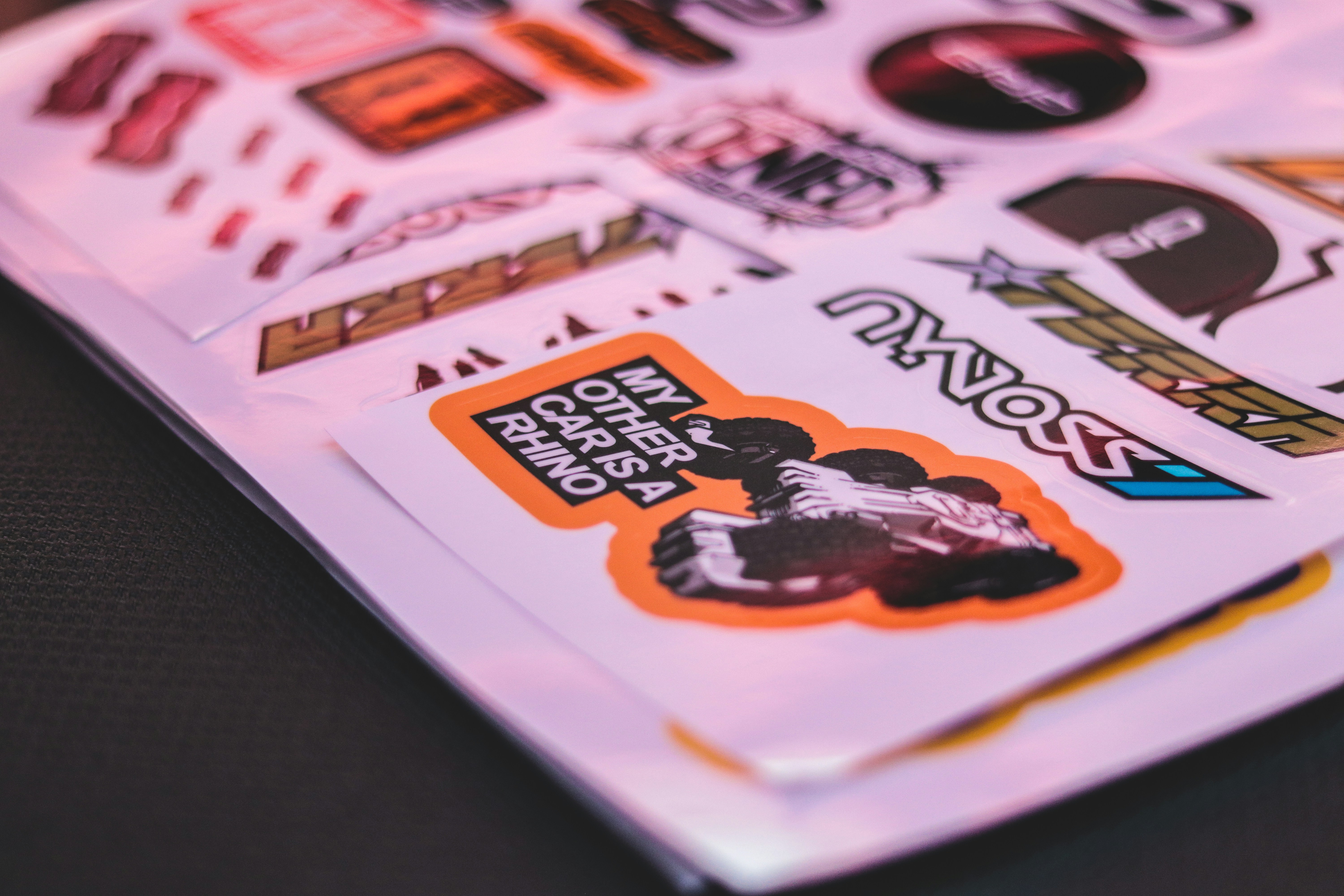 Colorful Sticker Stack on a Dark Surface