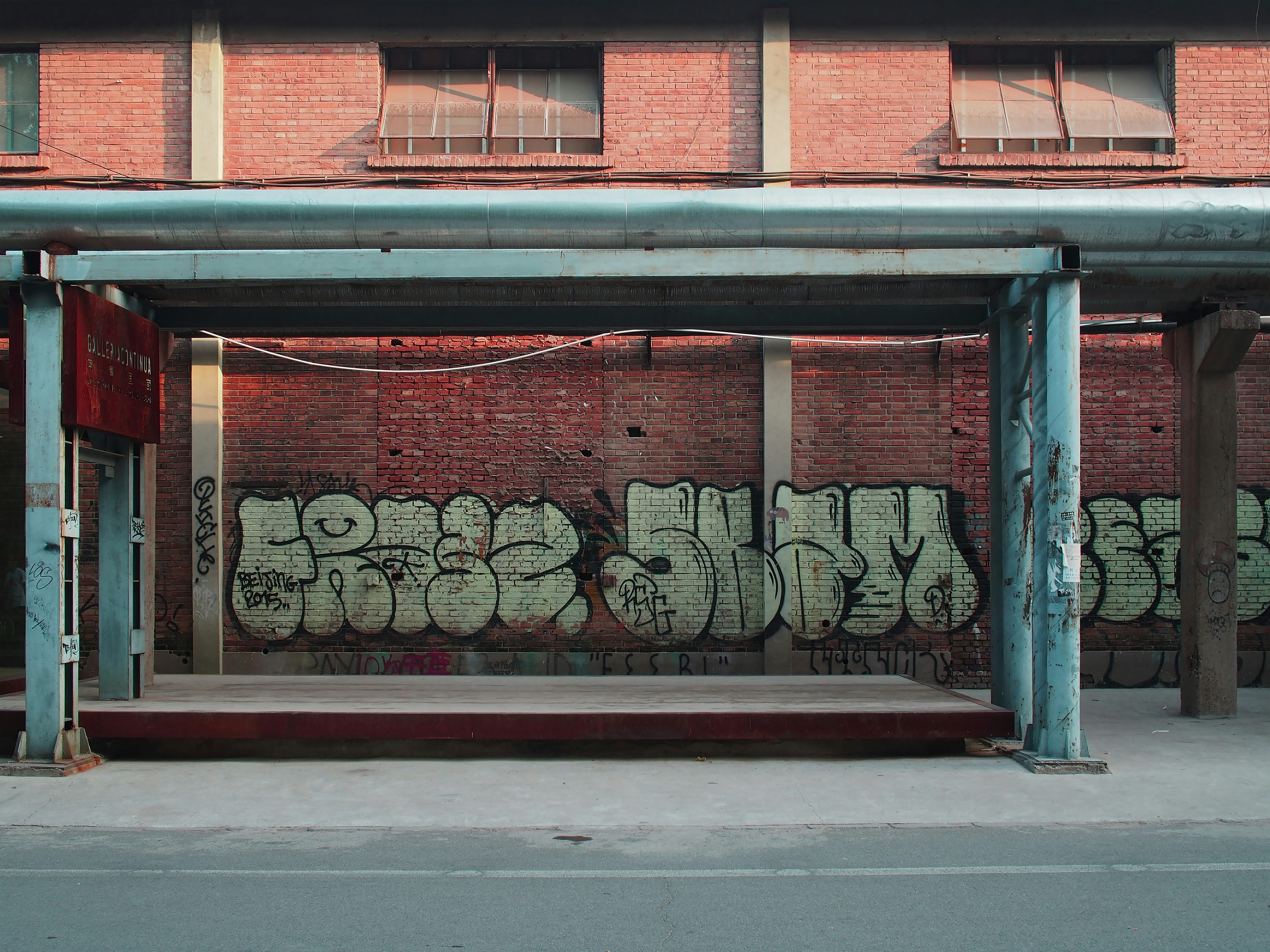 Graffiti Corridor Under Turquoise Canopies