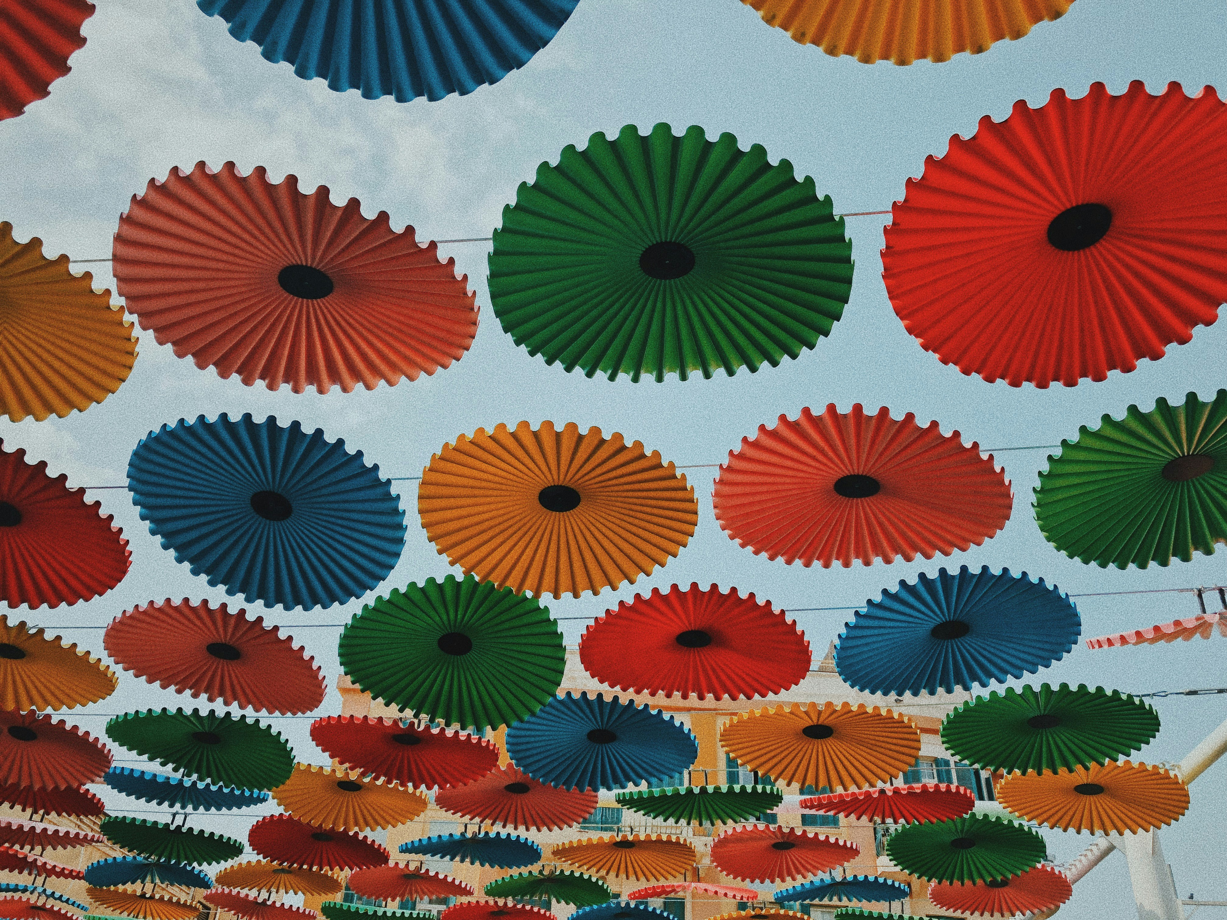 Color Cascade: Overhead Paper Fans Framing a Summer Sky
