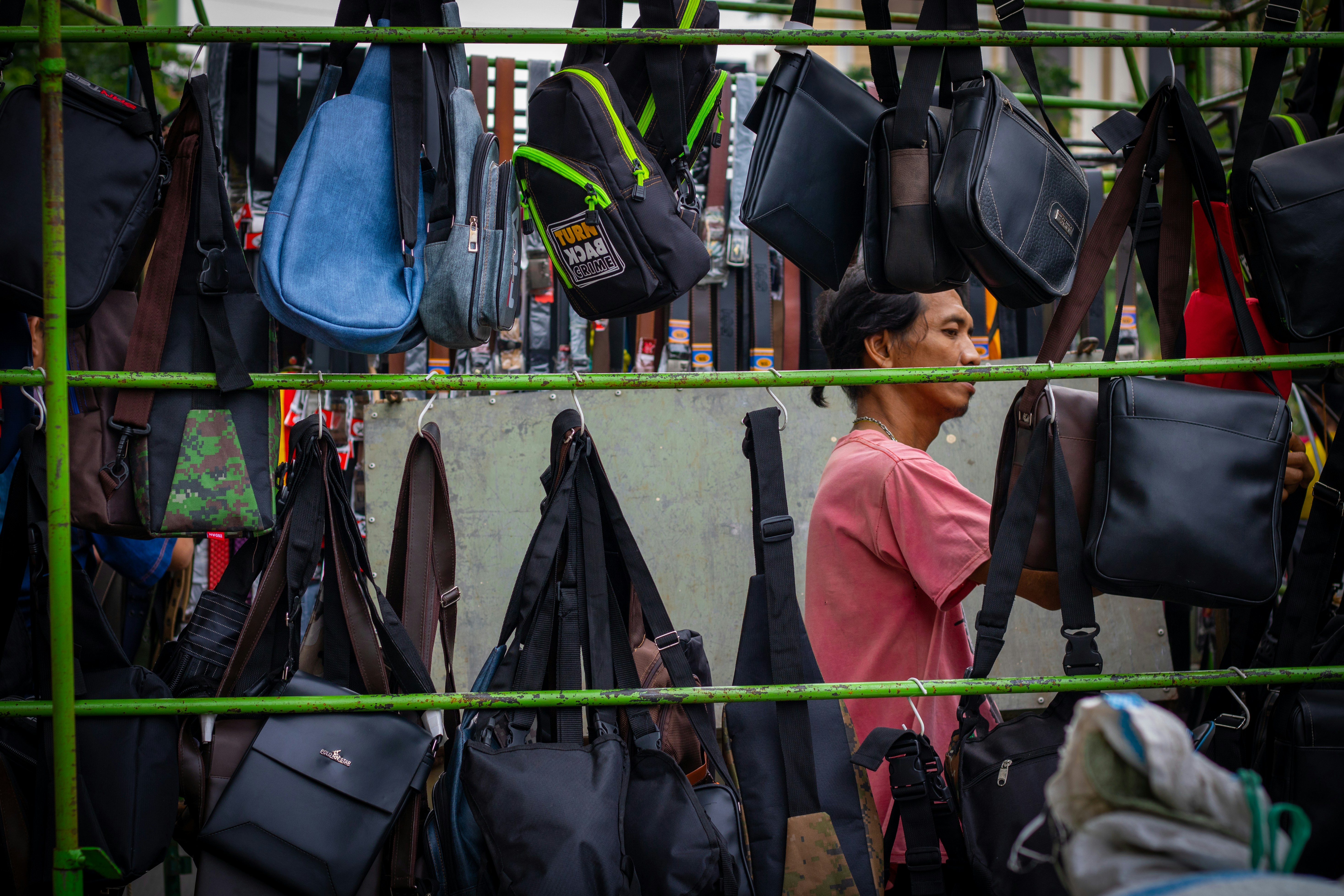 Man standing behind bags photo – Free Bag Image on Unsplash