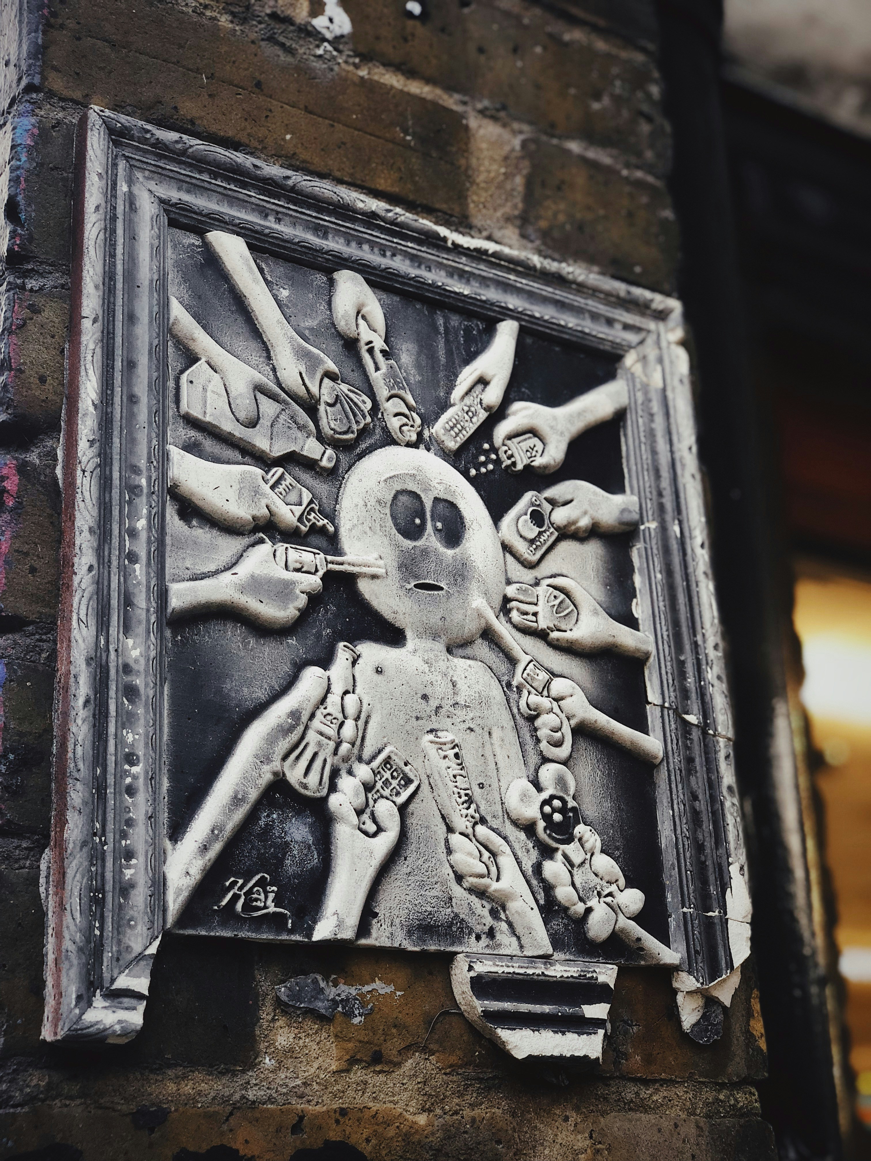 Sculpted Chorus of Hands: A Street Relief Centered on a Central Figure