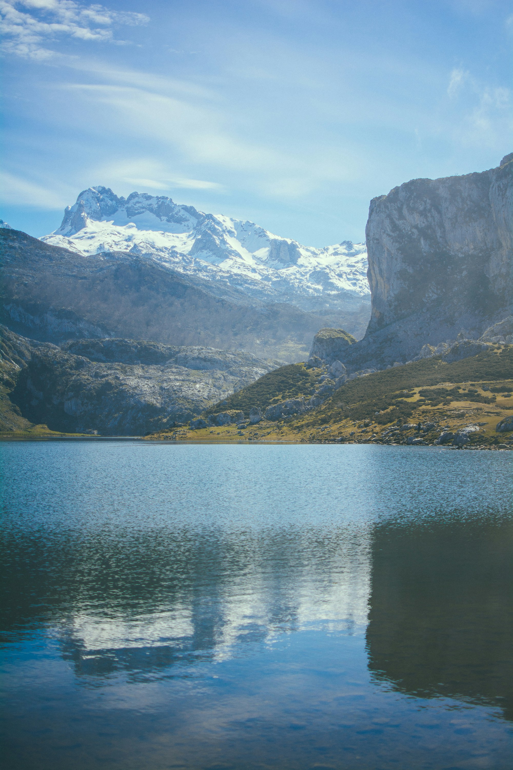 Mirror of Peaks: Snow-Capped Range Reflected on Quiet Alpine Lake