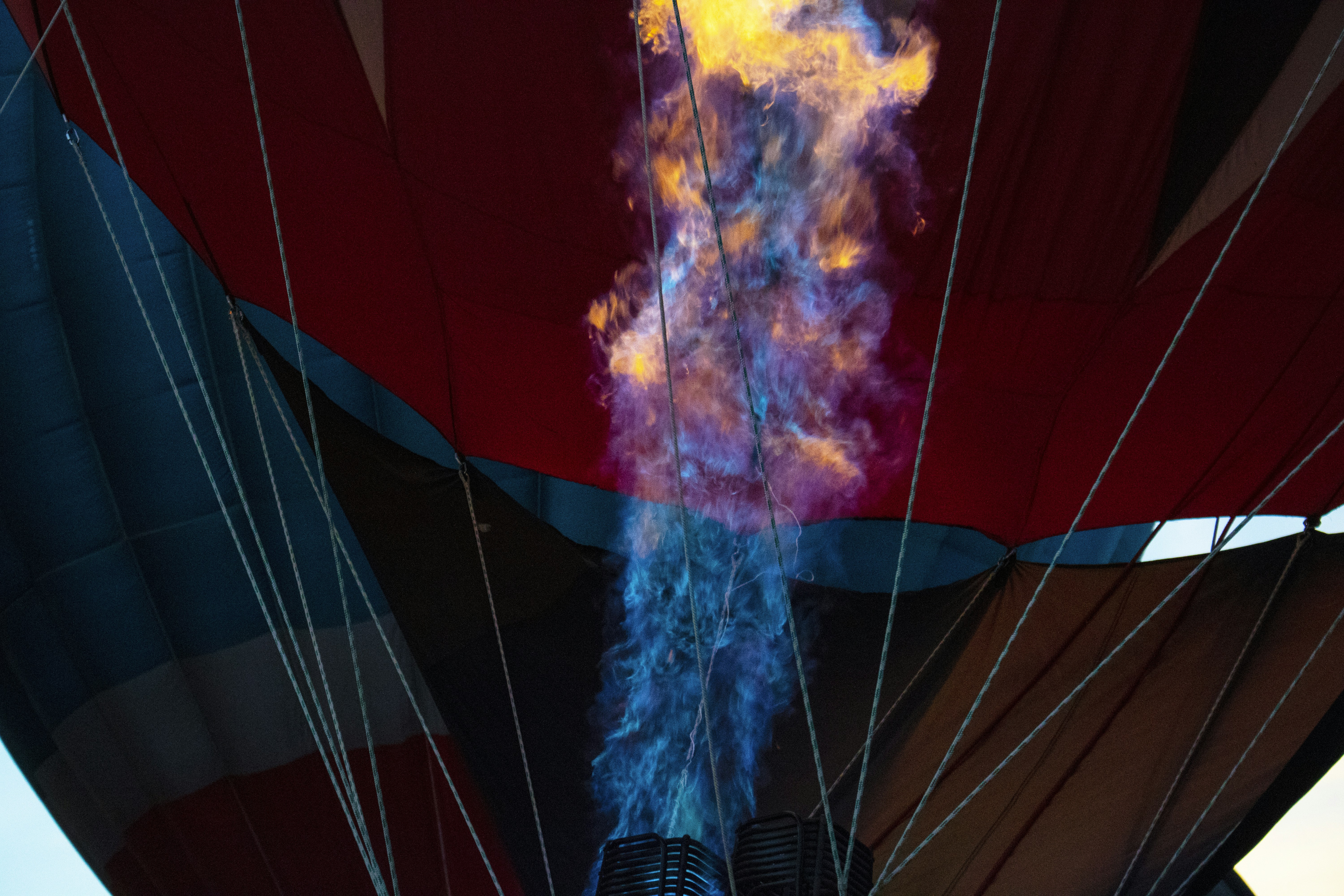 Center Flame Pierces a Colorful Balloon Envelope
