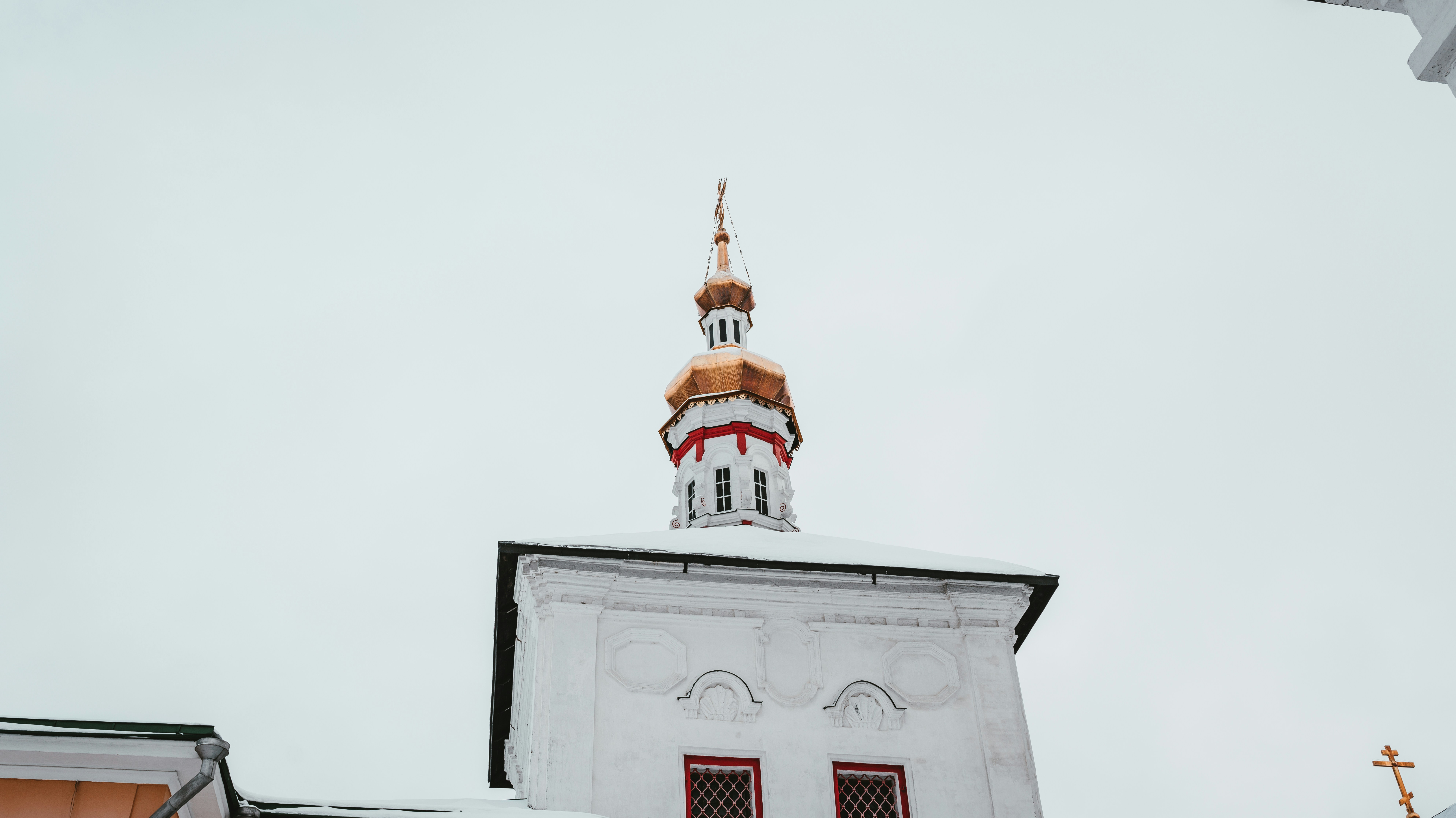 Coral Crown on a White Church Tower Against a Pale Winter Sky