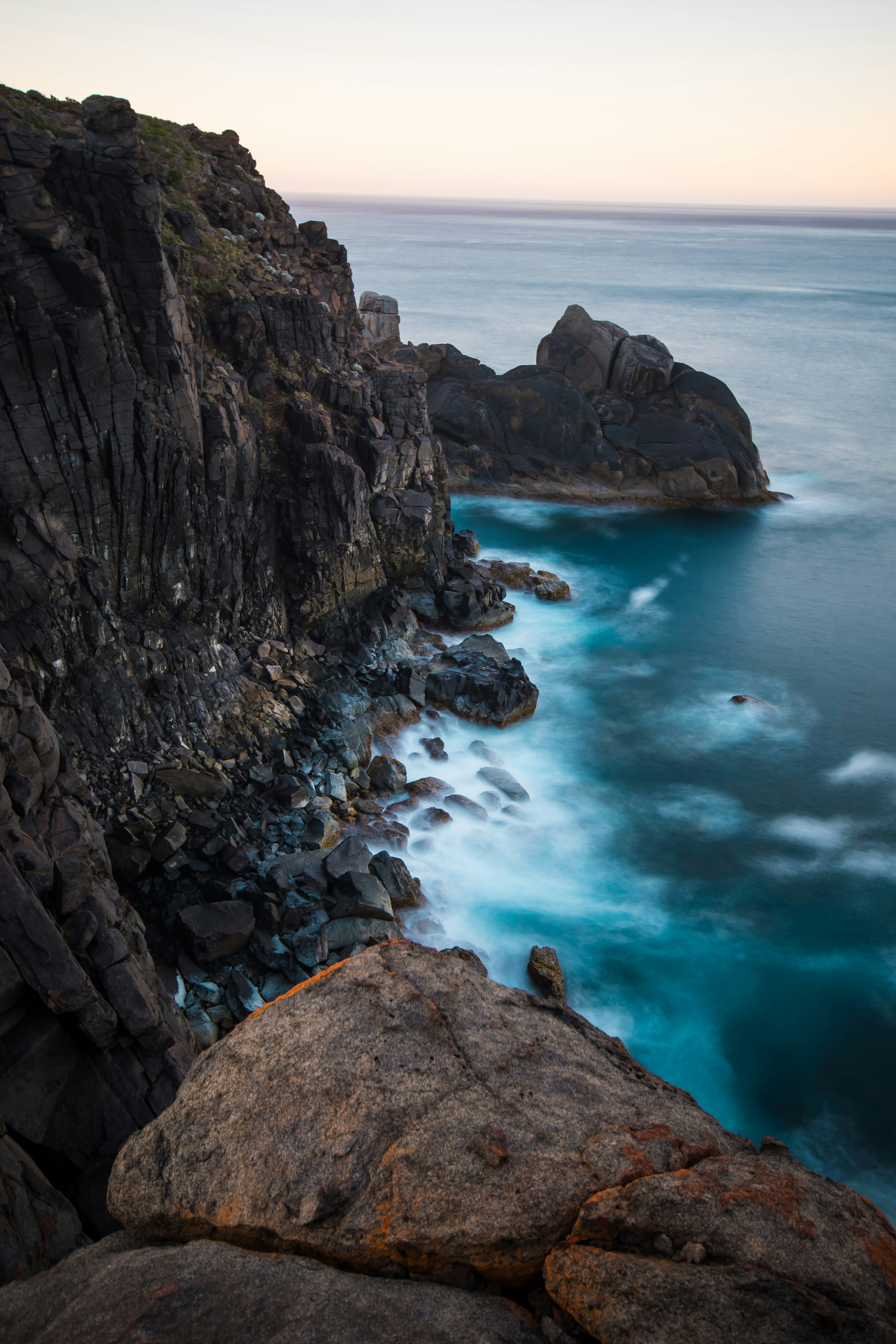 Aerial photography of water clashing on brown stone formation photo ...
