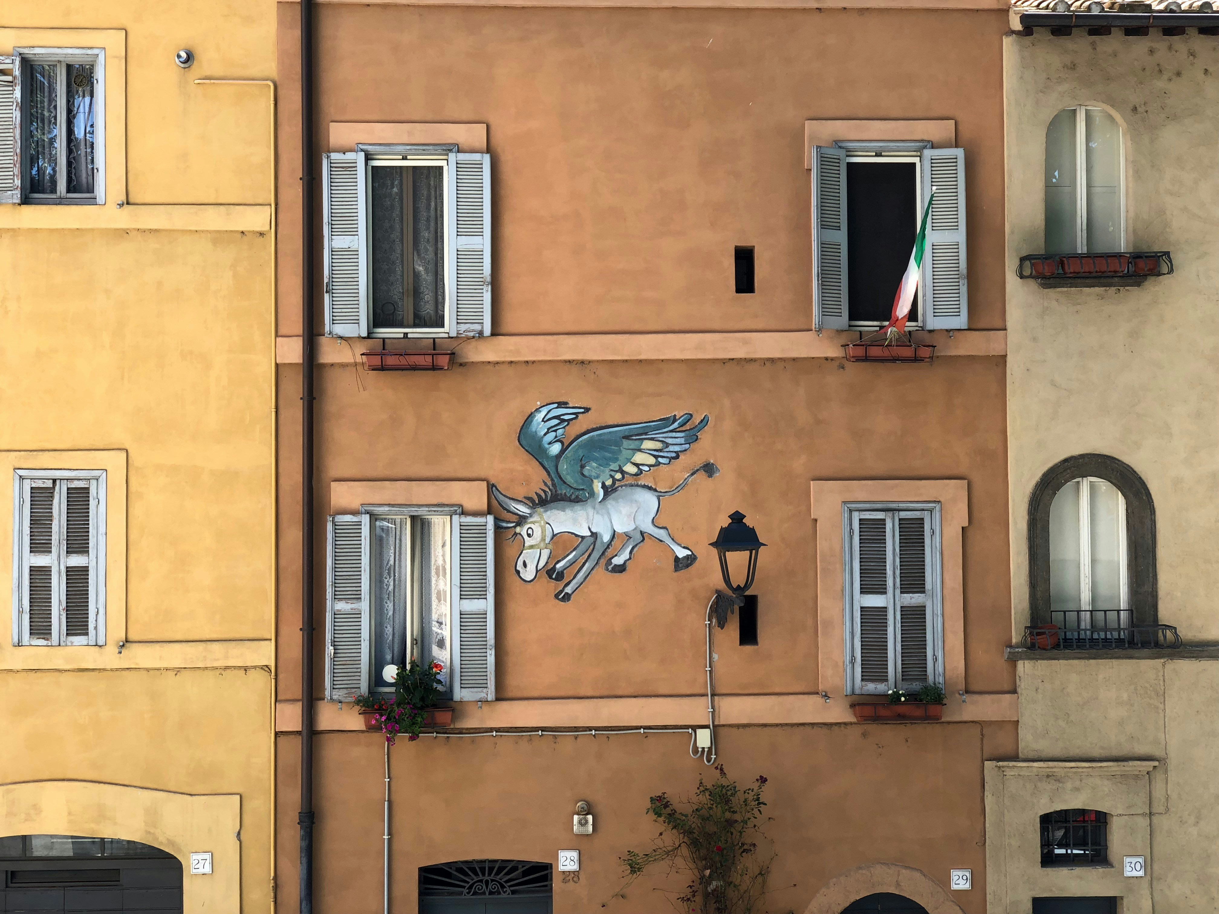 Winged Pegasus Adorns a Sun-Washed Italian Facade