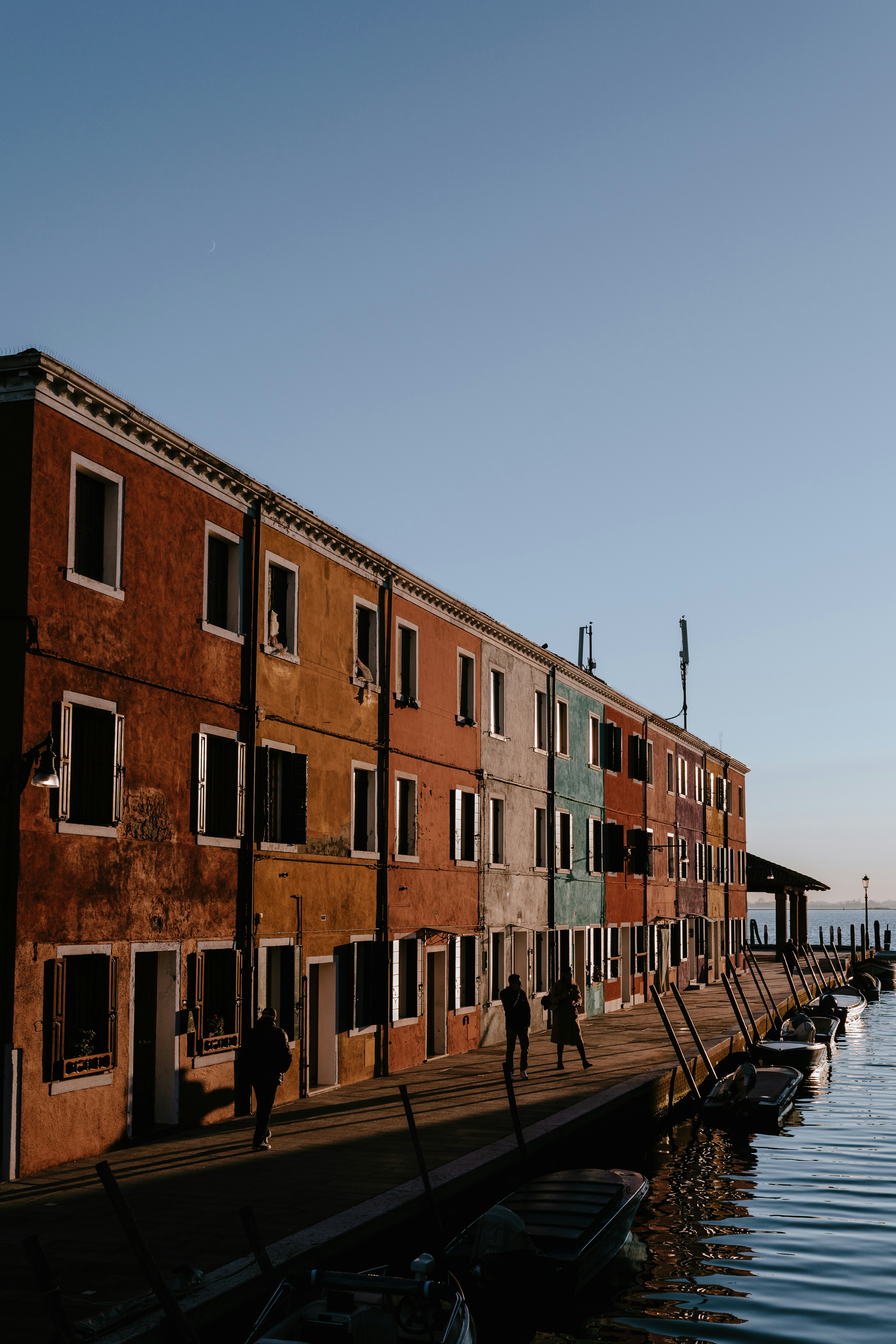 Golden Hour Rows: Multicolored Facades by a Serene Canal