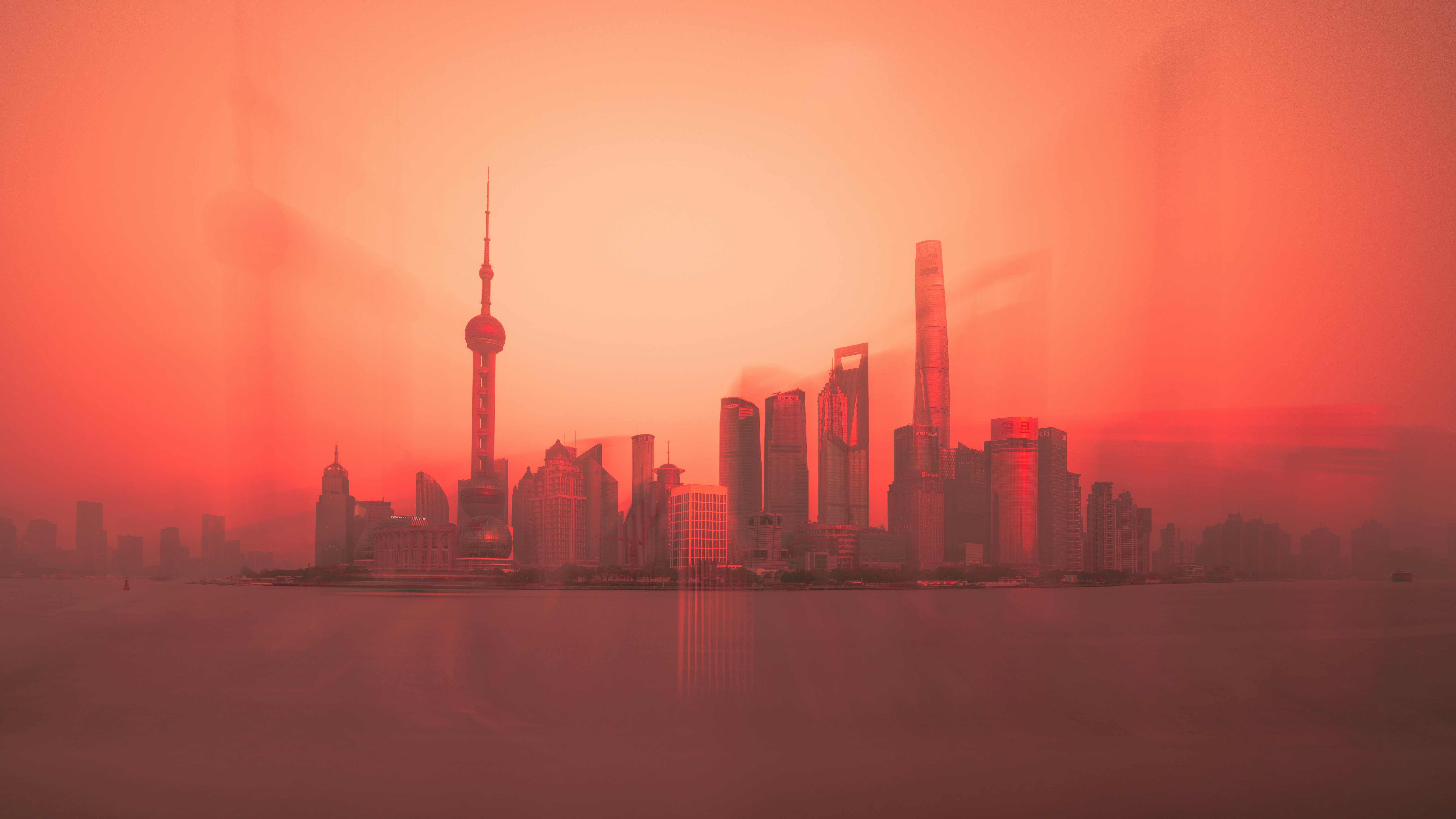 Abstract cityscape painting with skyscrapers silhouetted against a vibrant red-orange sky.