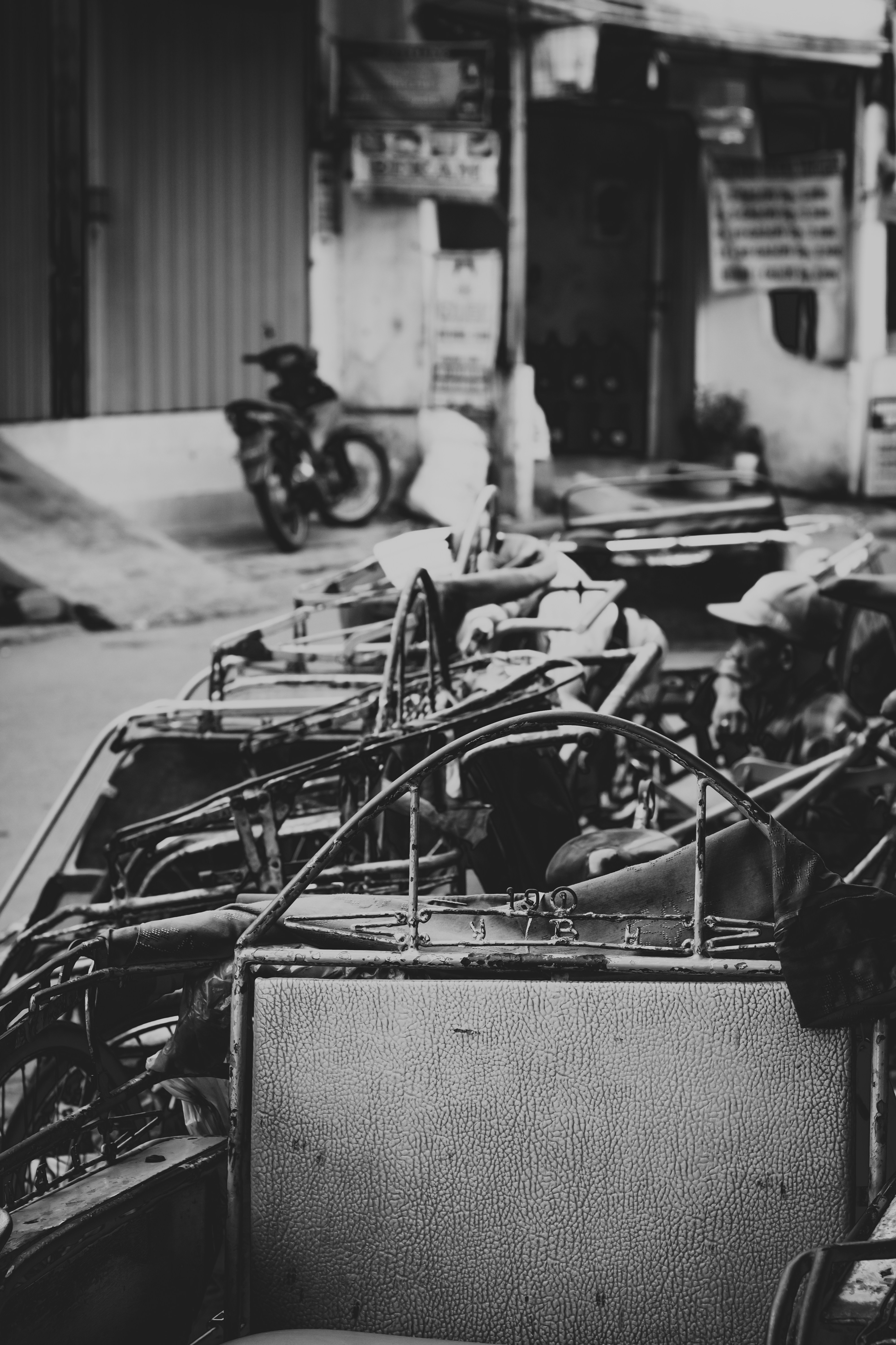 Rusted Parade: A Monochrome Street Scene of Worn Bikes and Hidden Details