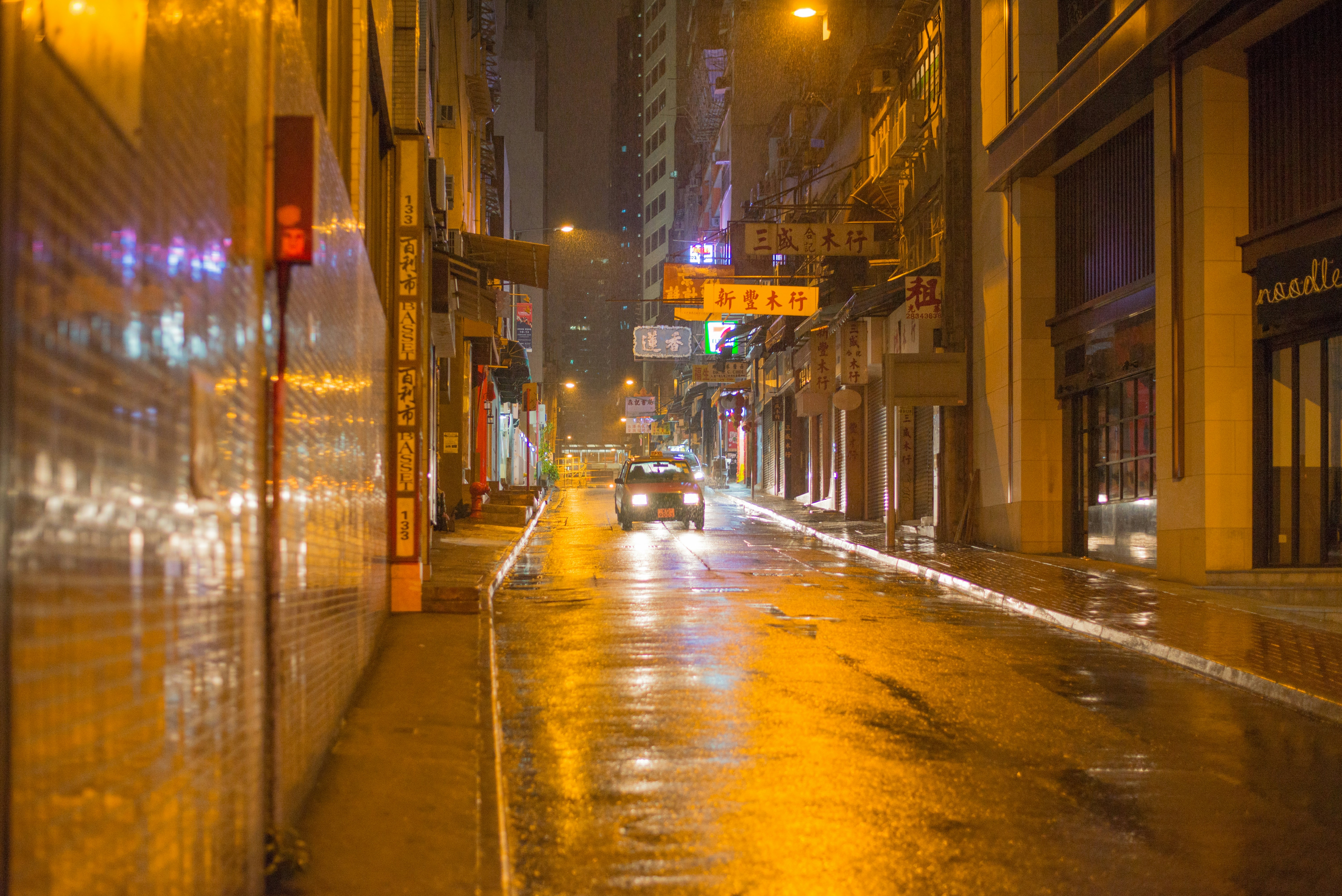 Car between highrise building photo – Free Asphalt Image on Unsplash
