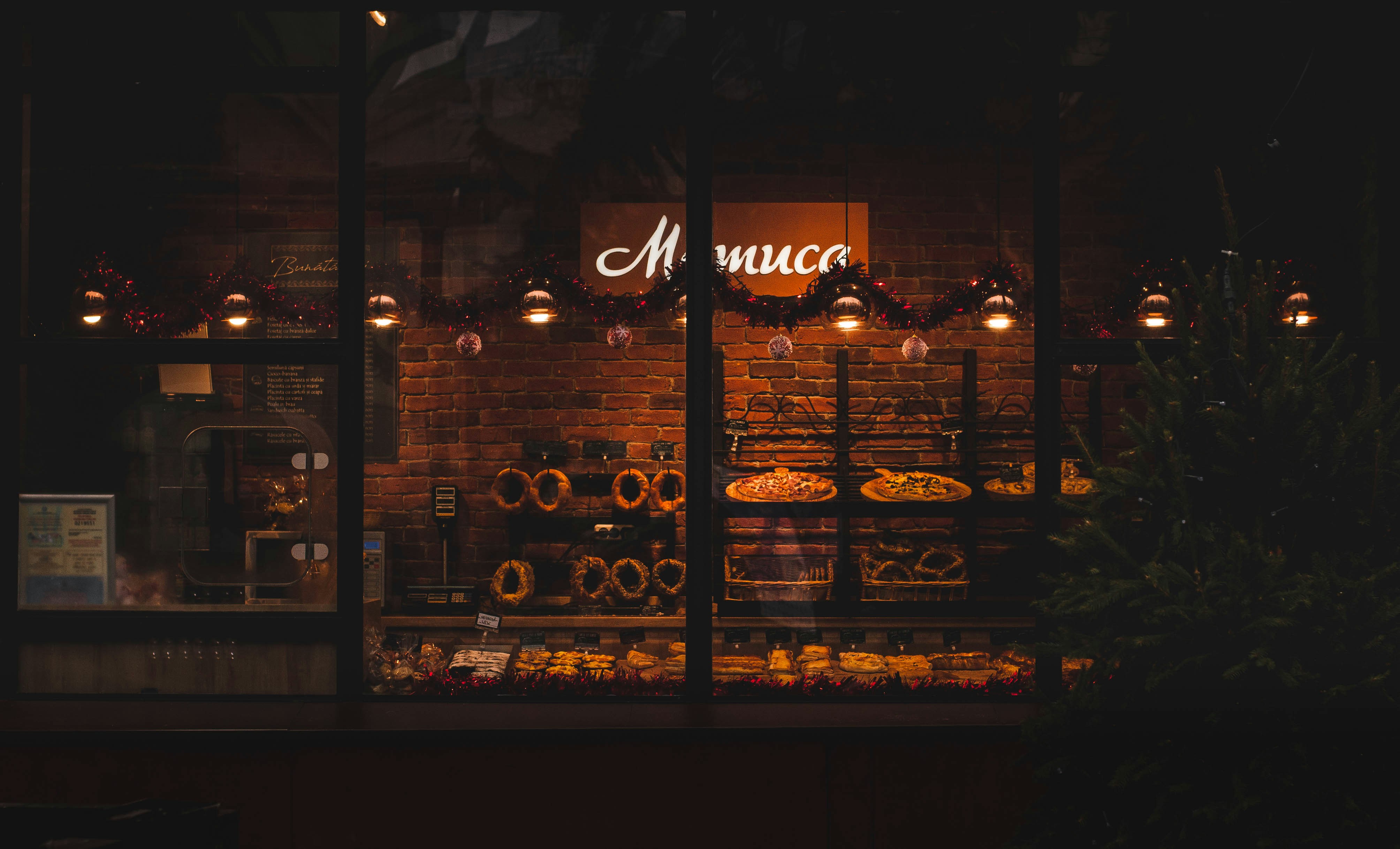 Warm glow through bakery glass: a late-evening display of breads