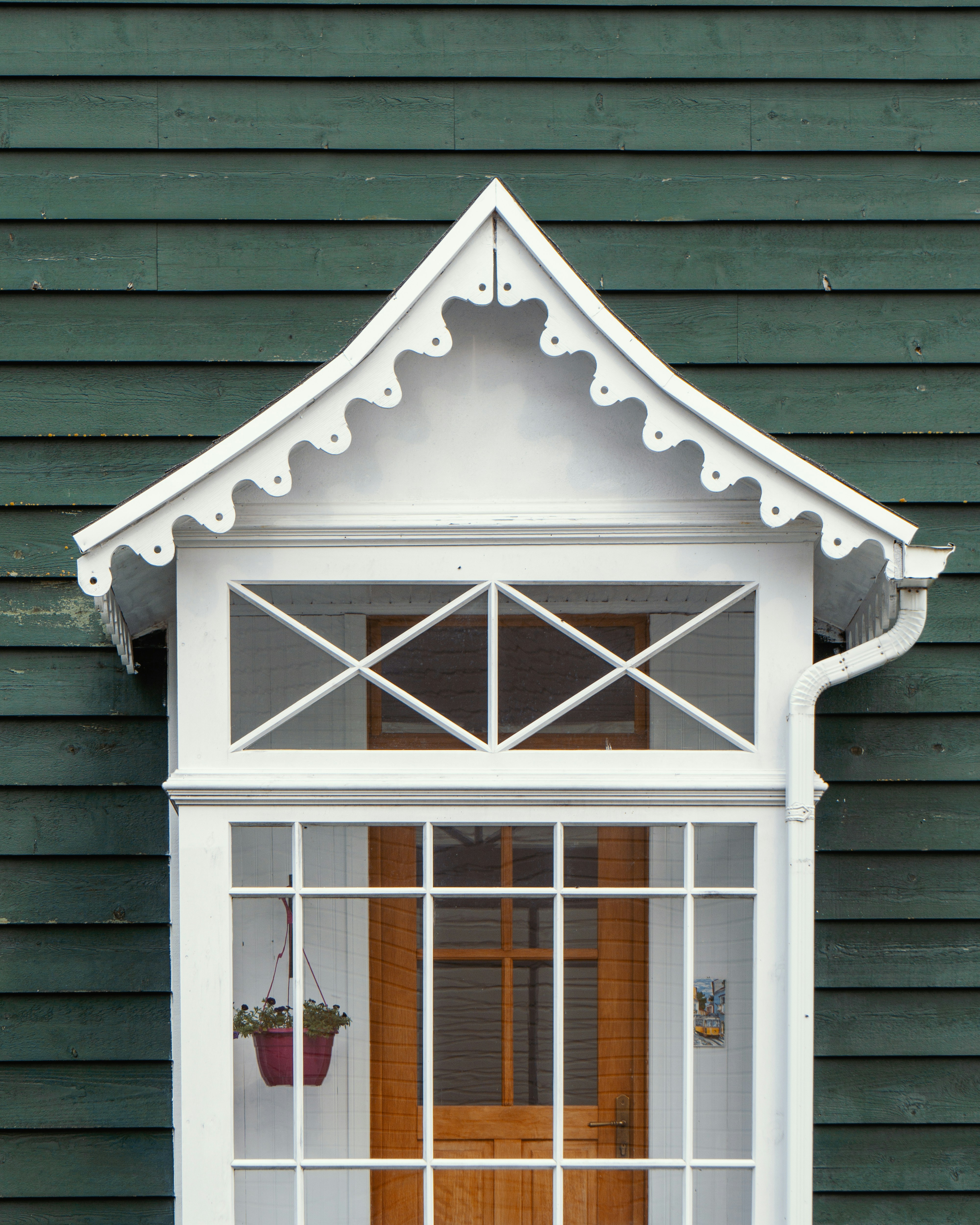 Emerald Facade Window: White Gable Trim with Crossed Panes