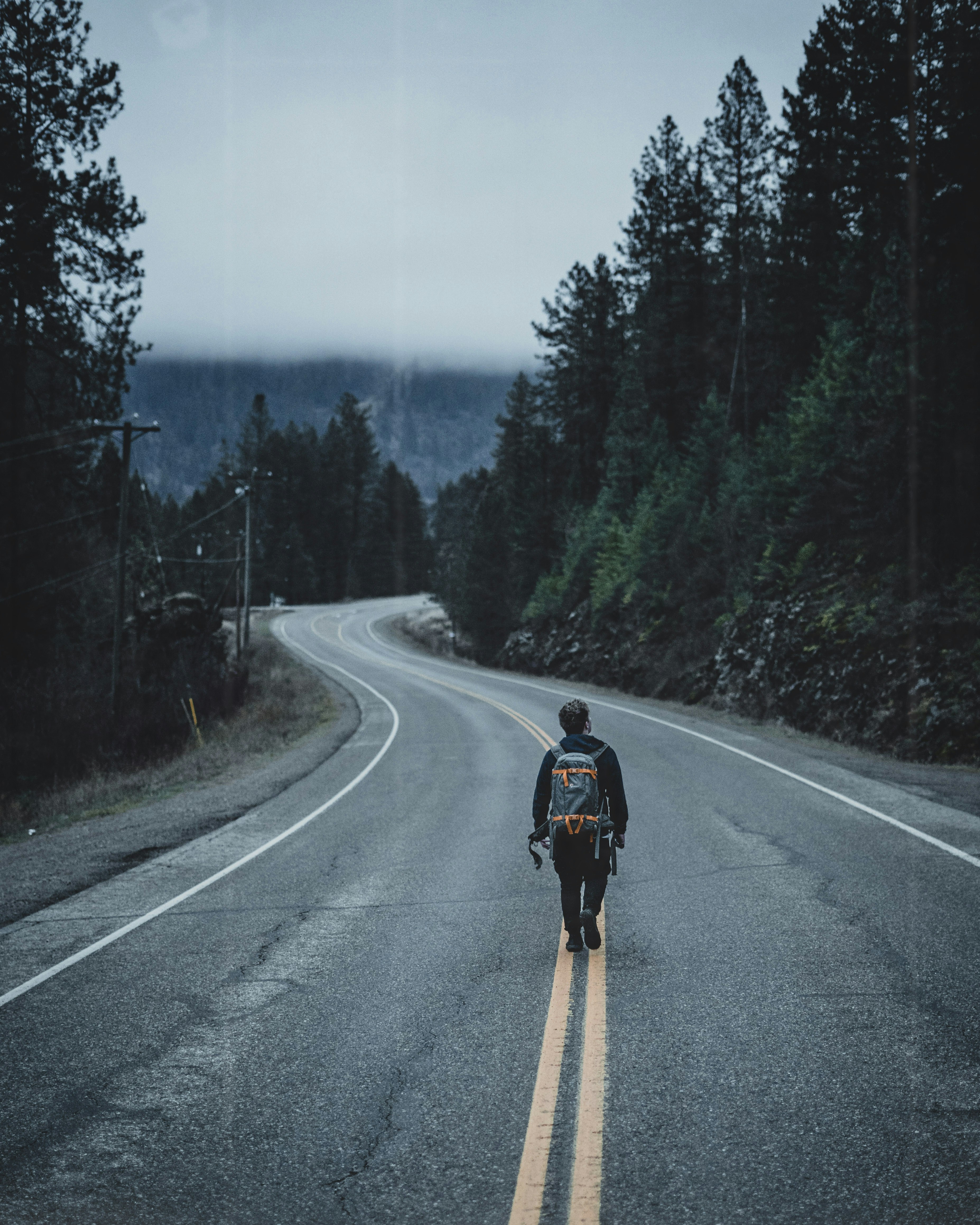 Man walking on road photo – Free Road Image on Unsplash