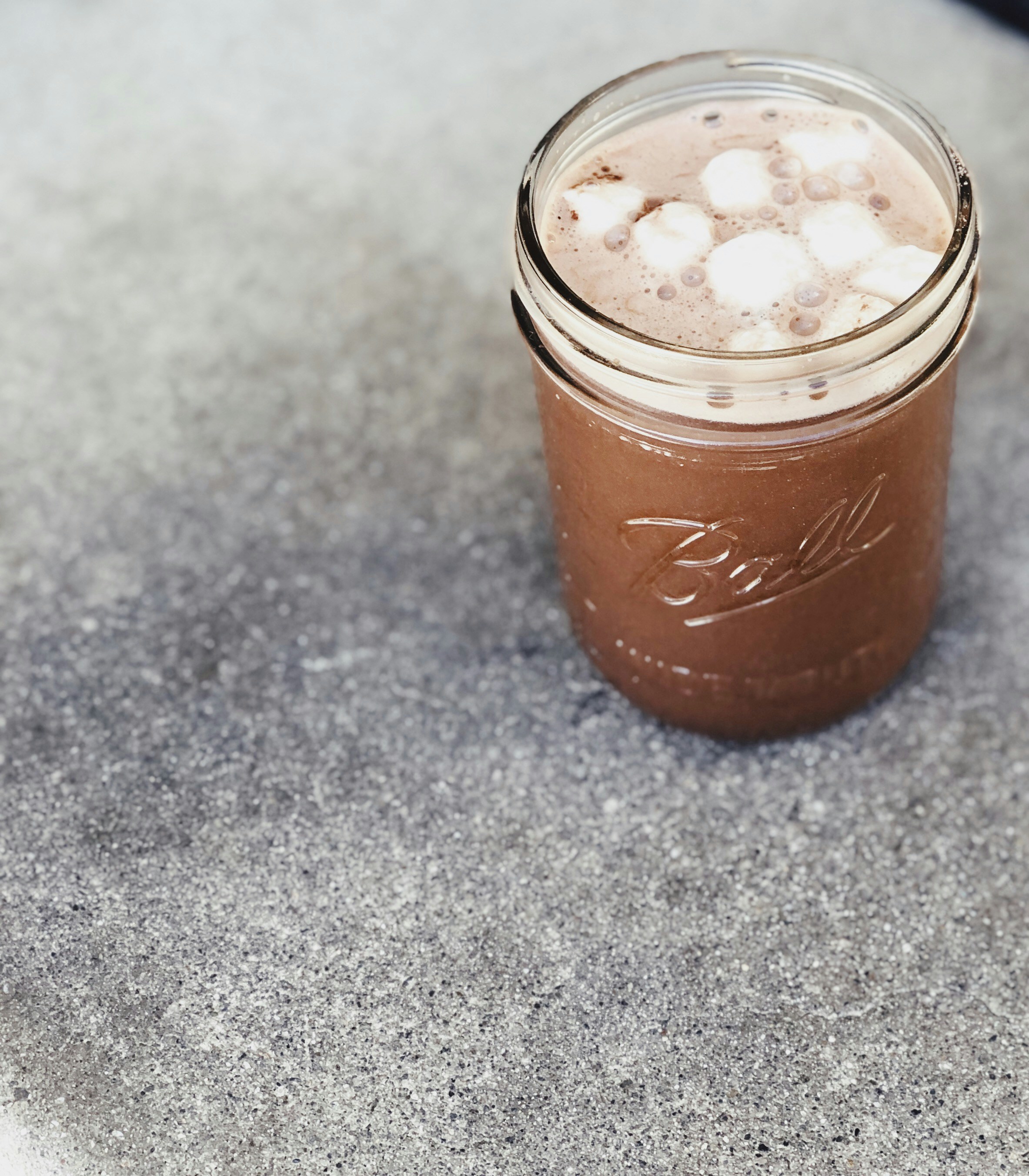Ball mason glass jar with brown liquid
