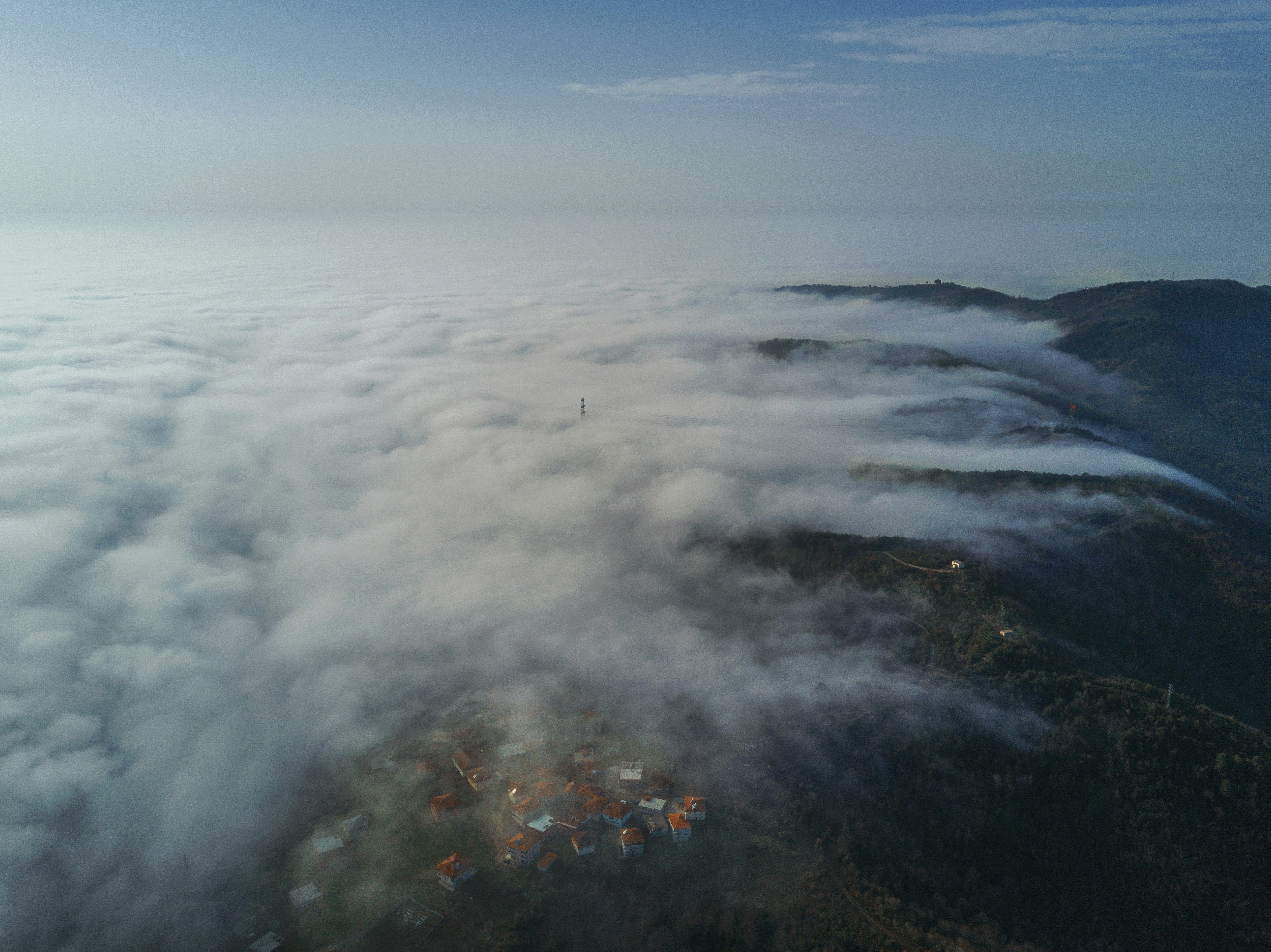 Whispers of Fog Over Hillside Village