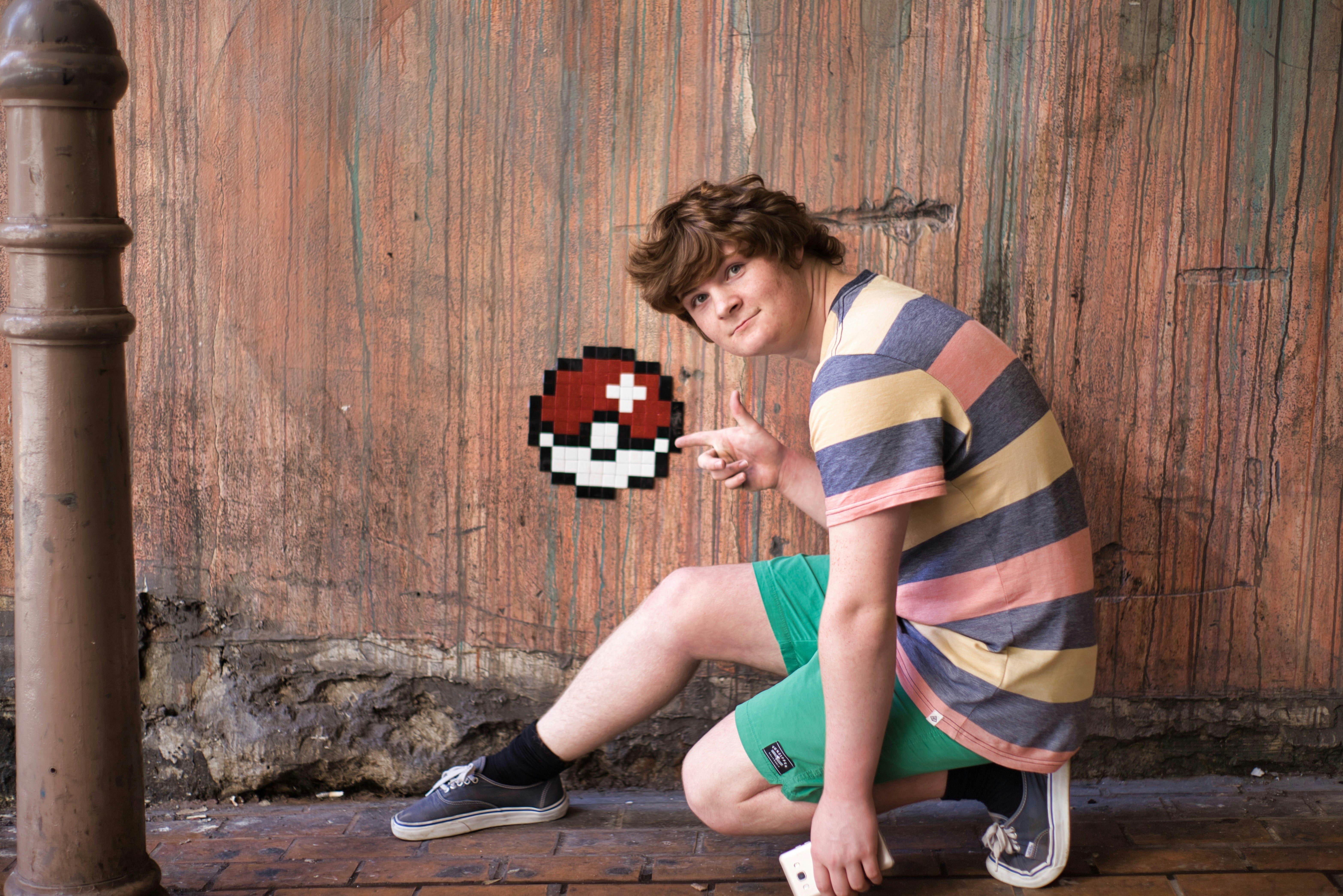 Man pointing pixelated pokemon ball photo – Free Boy Image on Unsplash