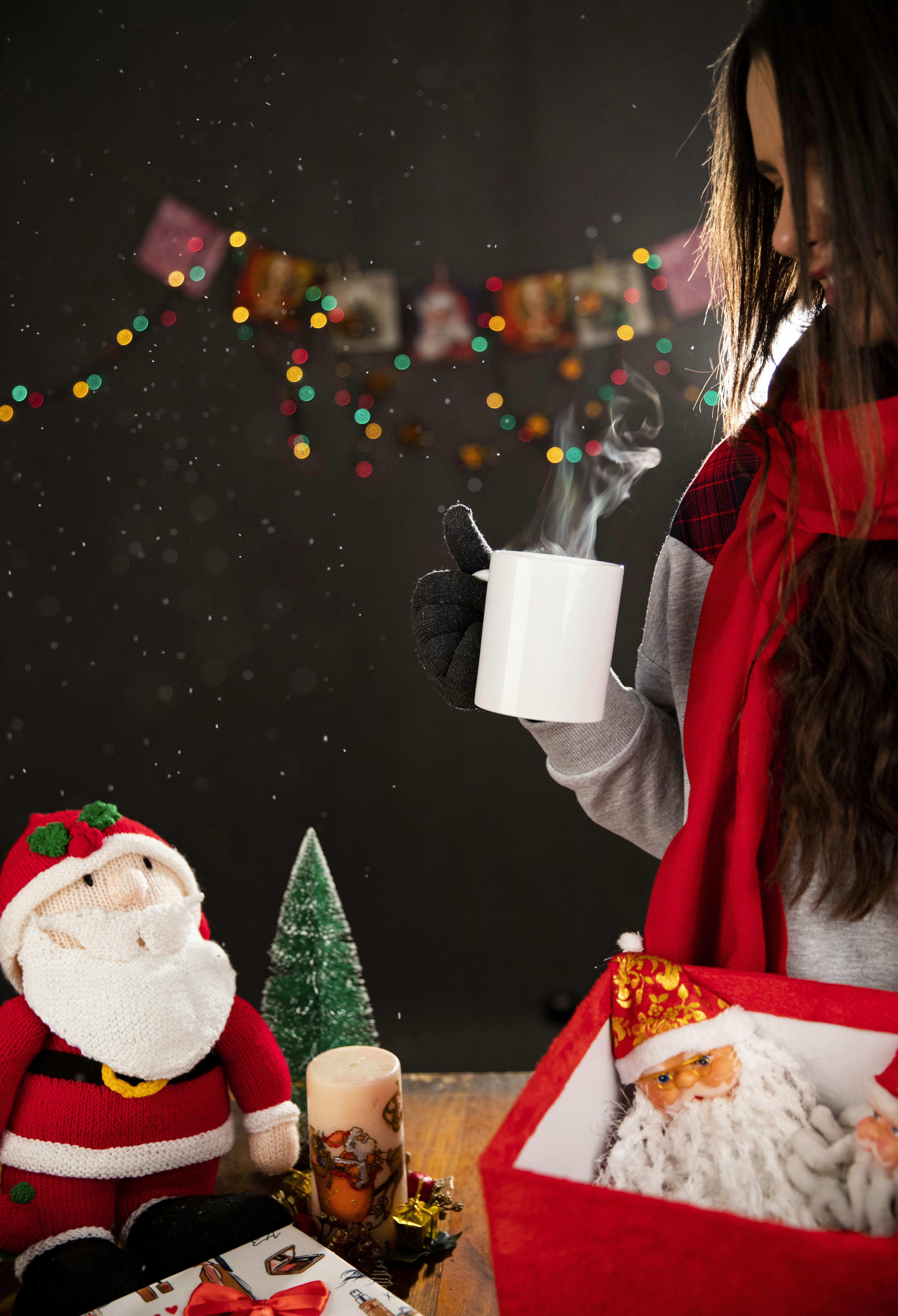 Steam and Holiday Glow: A Cozy Moment with a Mug, Santa Decor, and Fairy Lights
