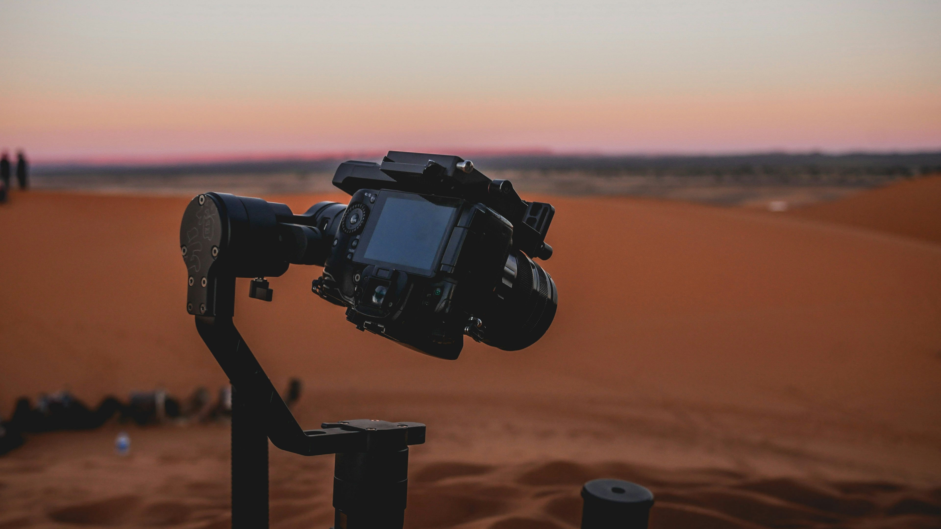 Dunes at Dusk: The Stabilized Gimbal Guarding the Quiet Horizon