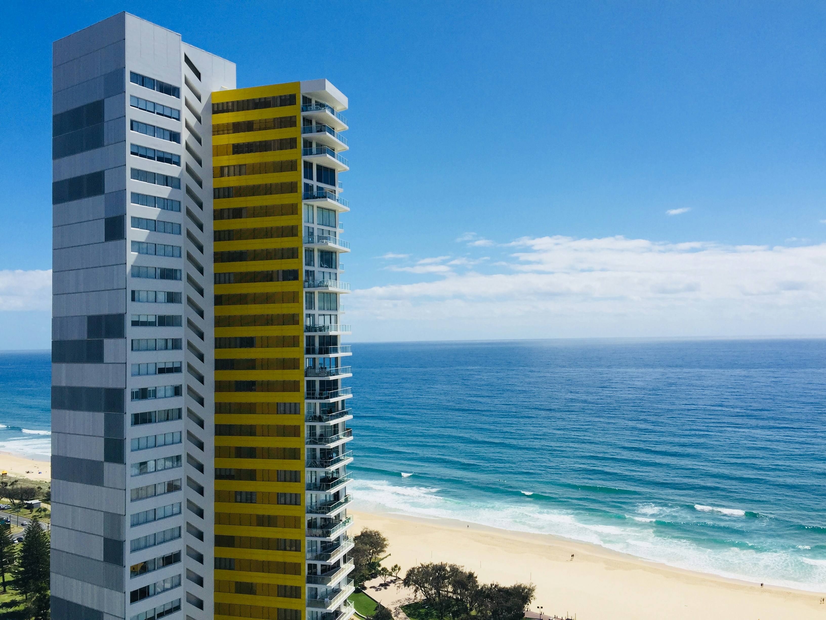 White and yellow high-rise building near sea photo – Free Beach Image ...