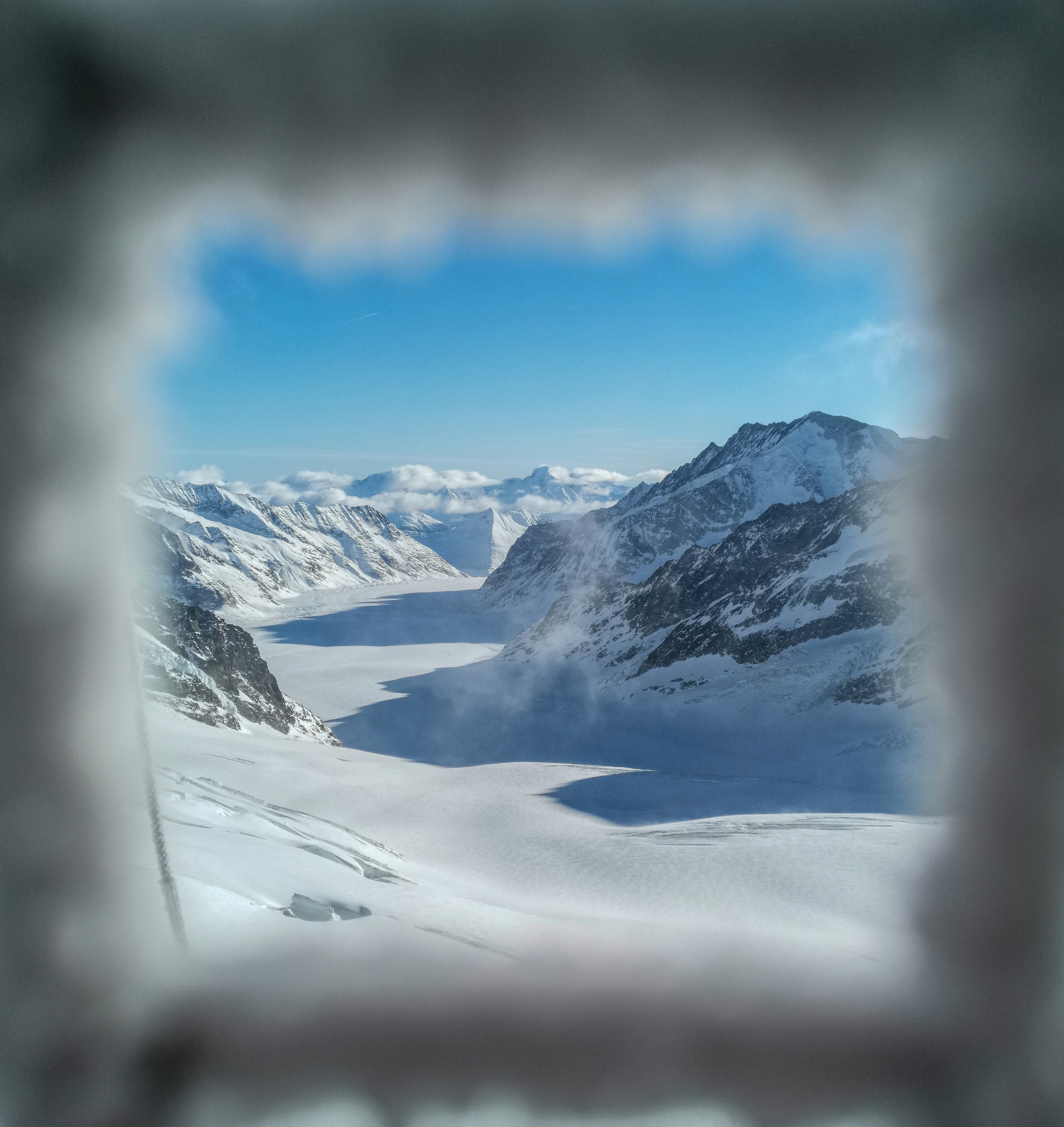Snowfield Window: A Glacial Valley Framed by Frozen Peaks