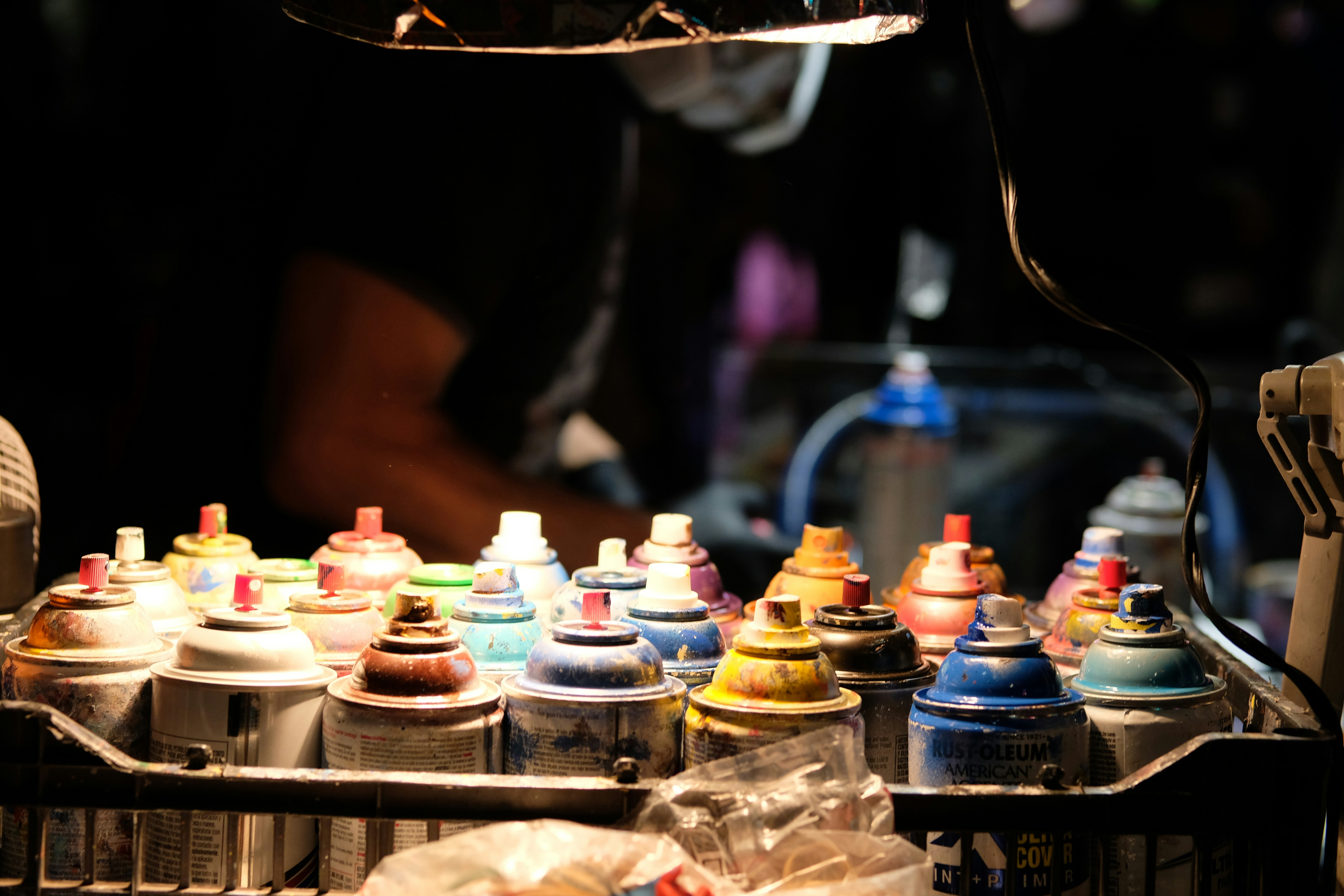 Chromatic Row of Spray Cans Under Warm Studio Glow