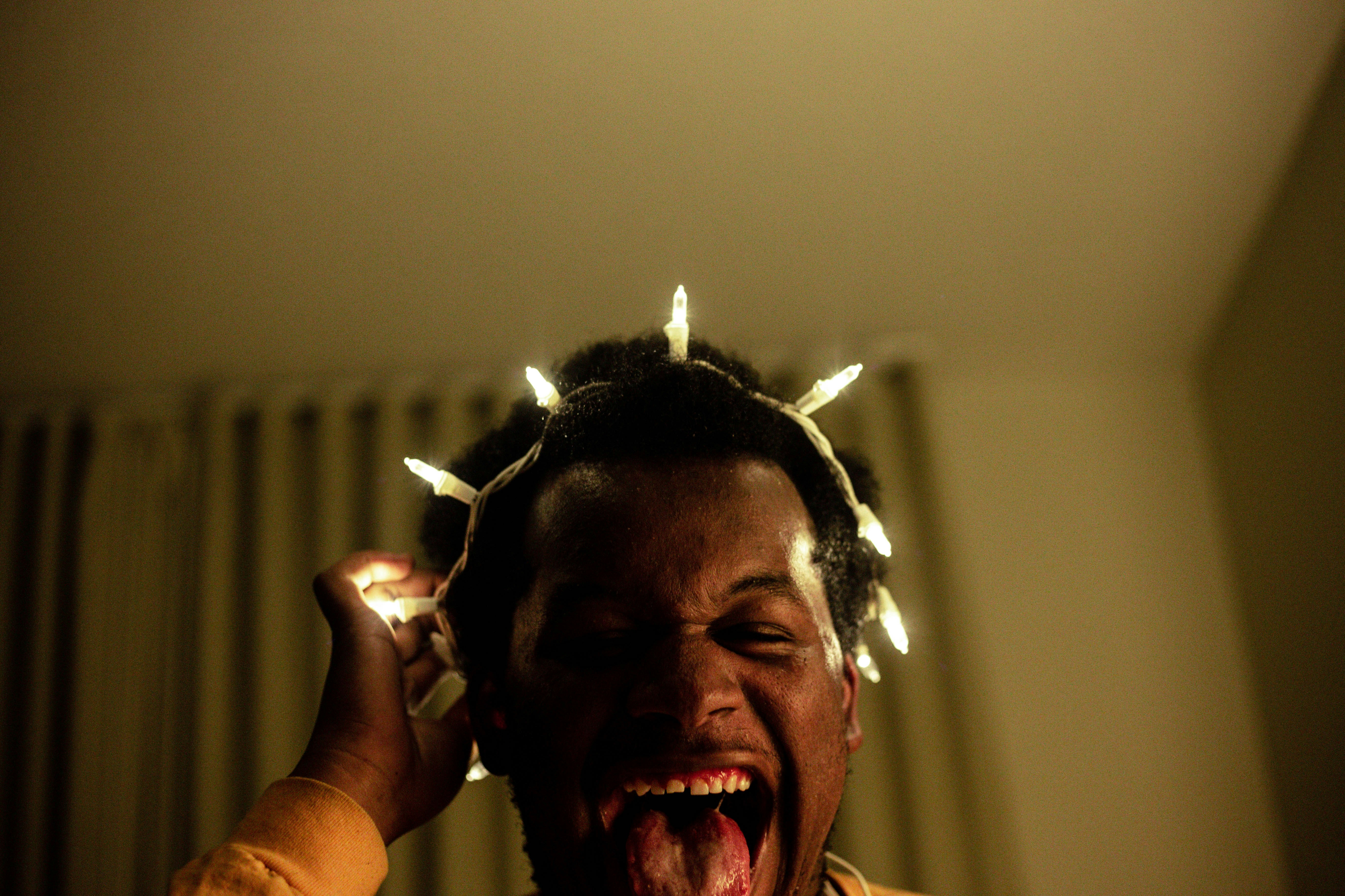 Festive Halo: A Laugh Under a Ring of Tiny Lights