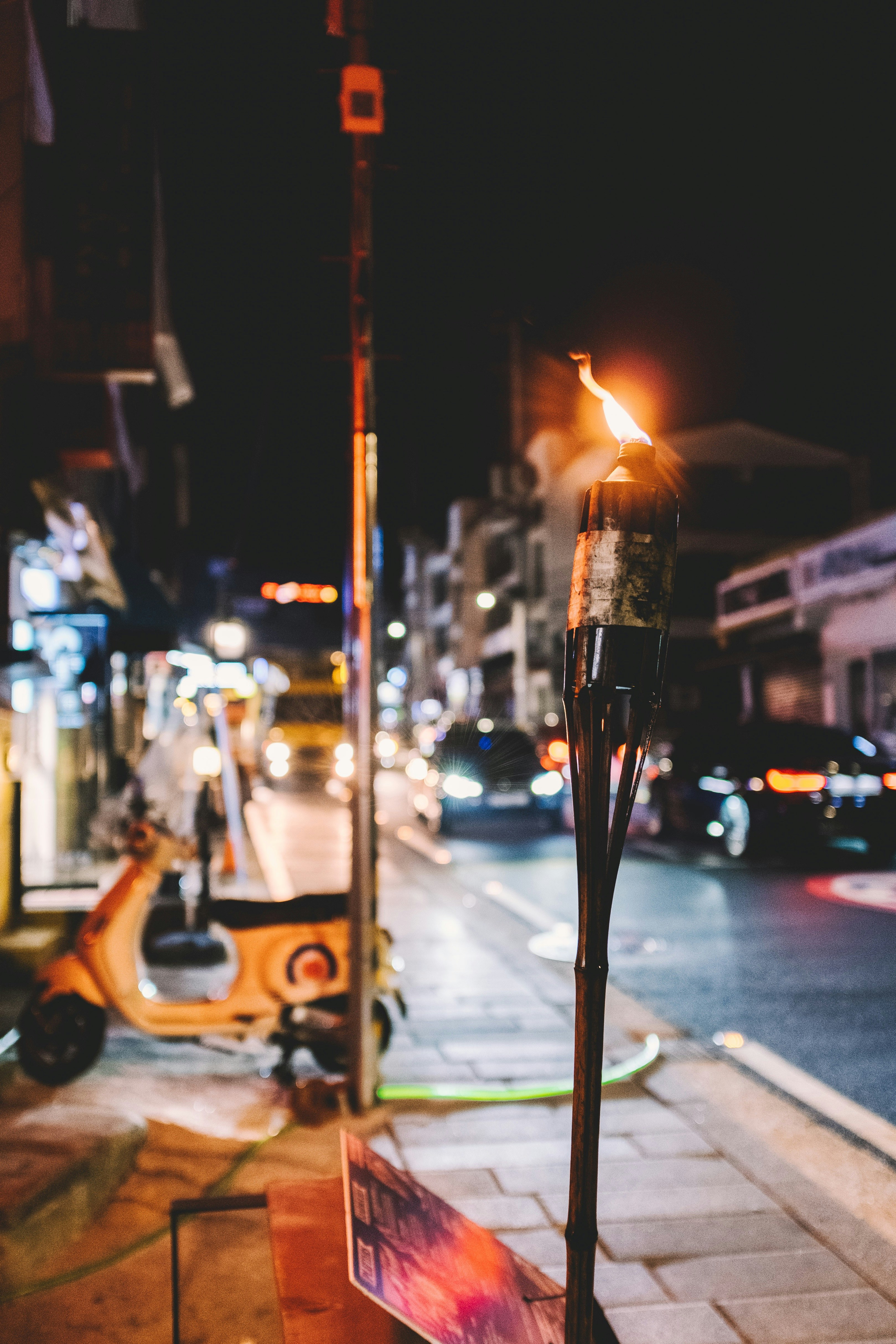Selective focus photography of lighted tiki torch on side walk photo ...