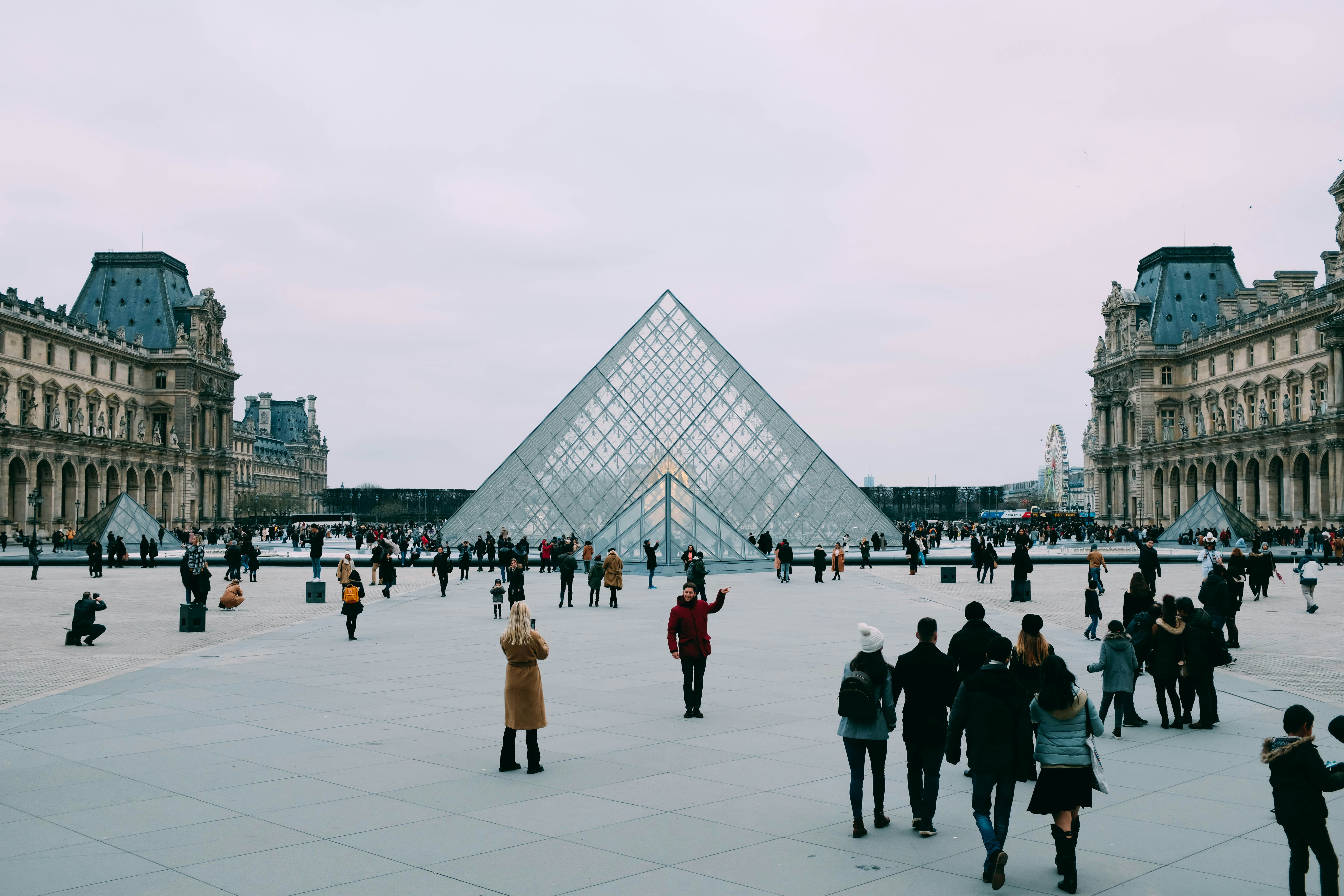 Group of people looking at The Lourve pyramid photo – Free Grey Image ...