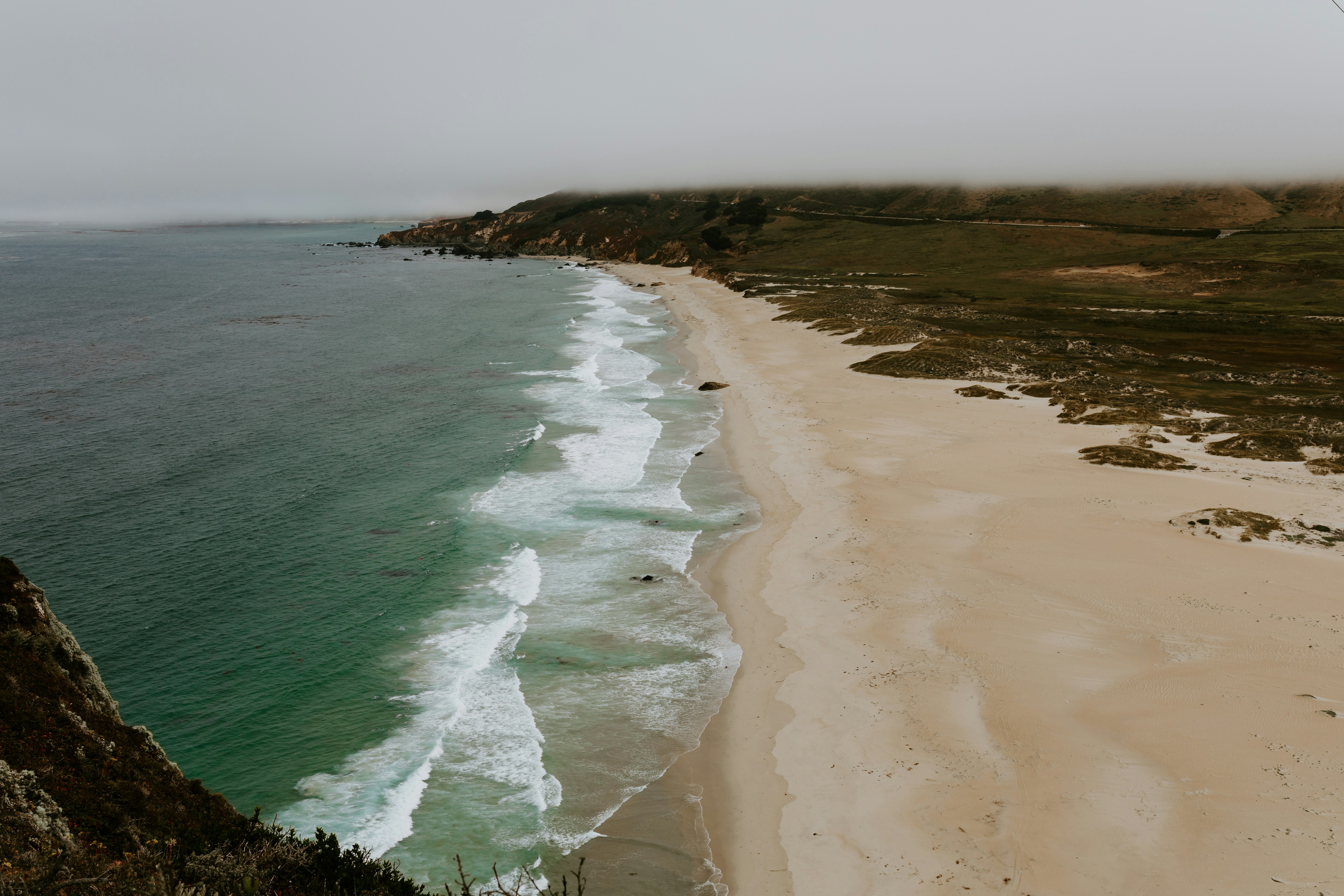 Green open field near sea during daytime photo – Free Nature Image on ...